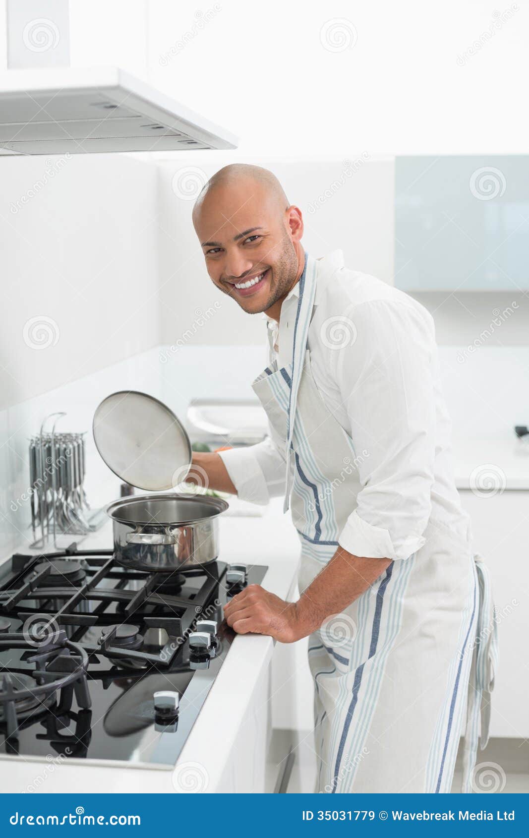 Side View of a Smiling Man Preparing Food in Kitchen Stock Image ...