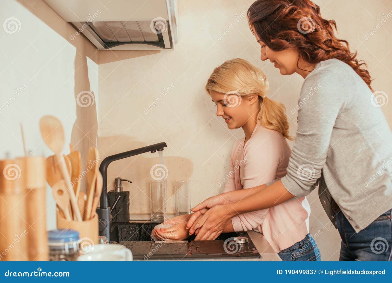 Side View of Smiling Mother and Stock Image - Image of girlhood, sink ...