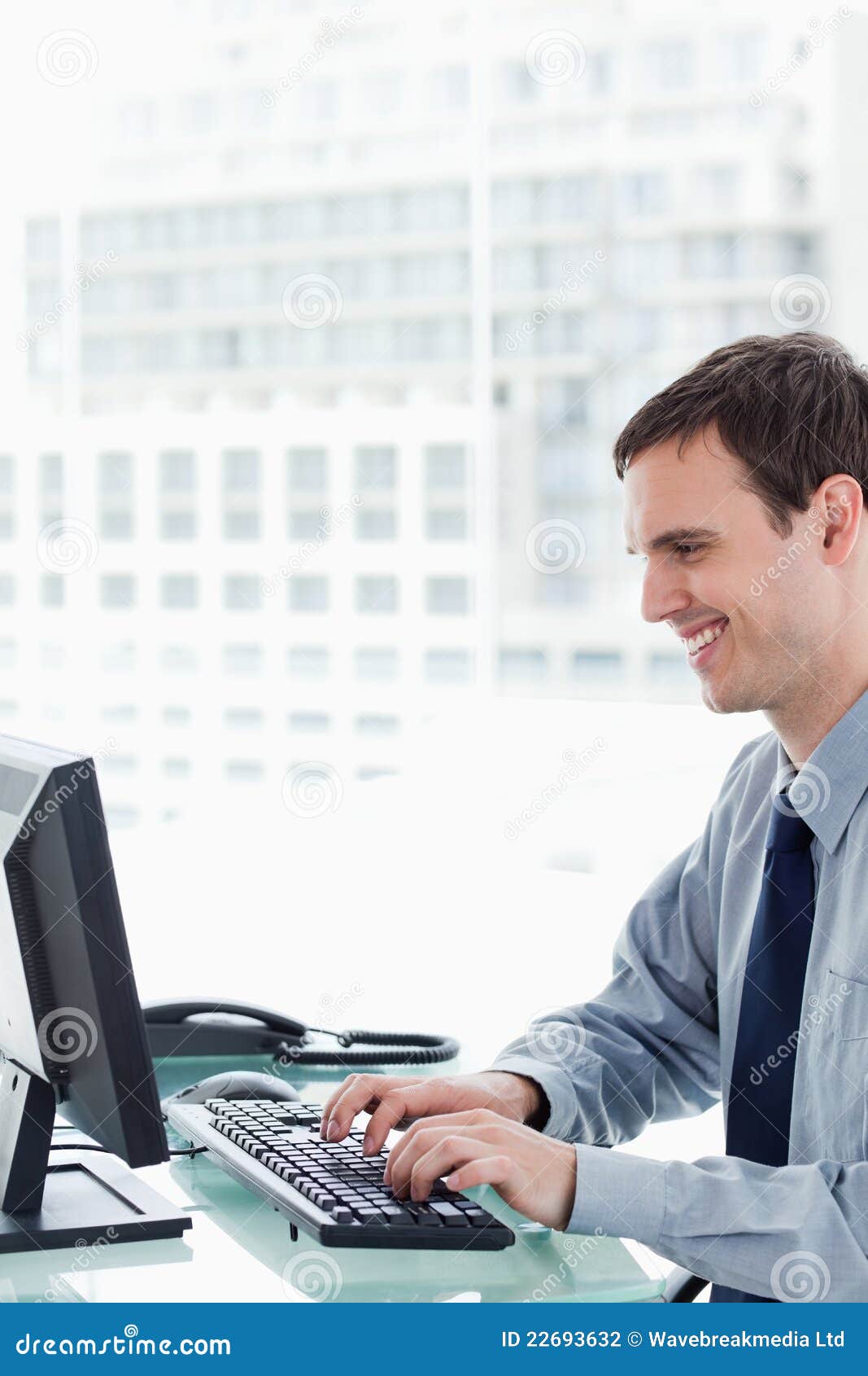 Side View of a Smiling Office Worker Using a Monitor Stock Photo ...