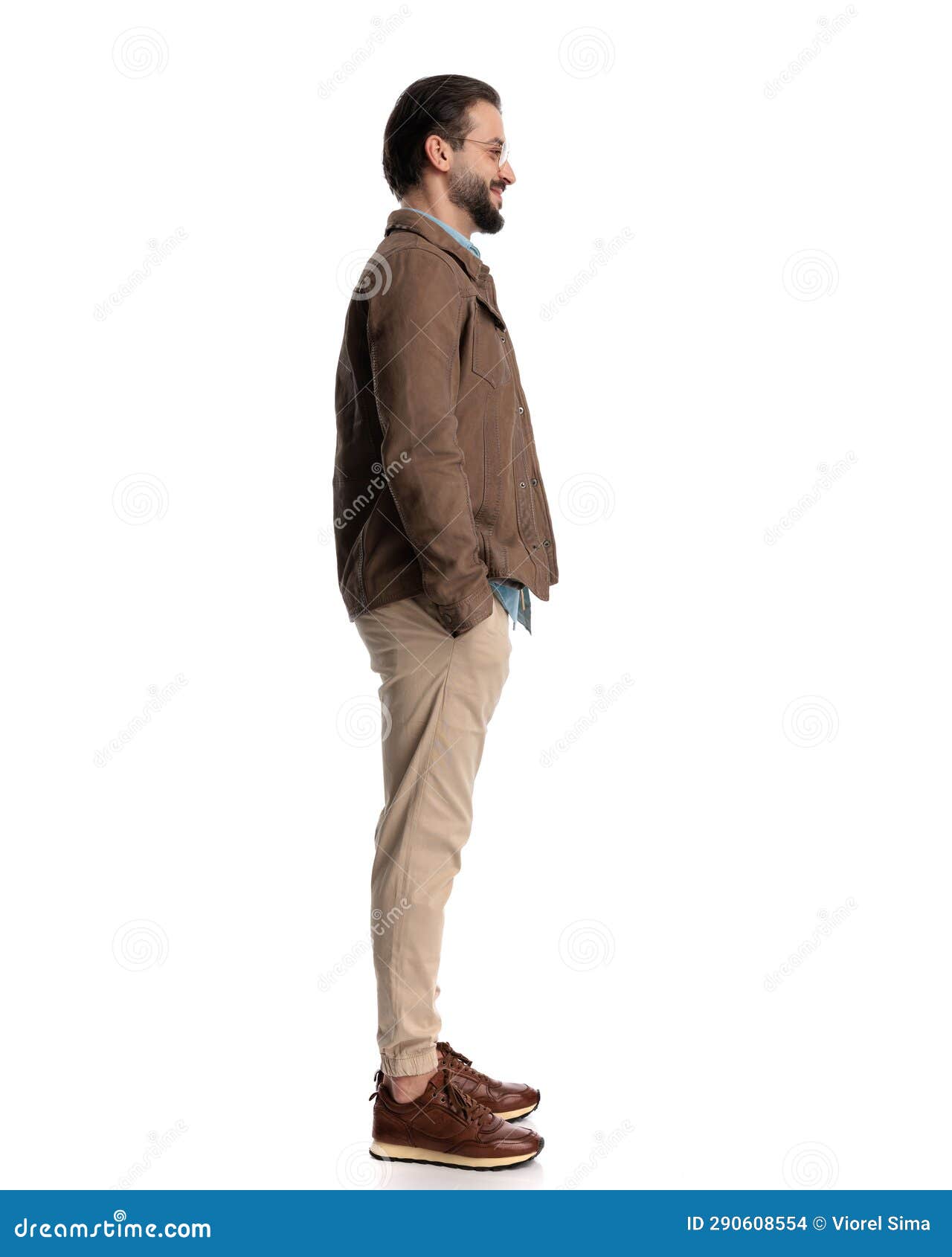 Side View of Smiling Young Man Looking To Side and Waiting with Hands ...