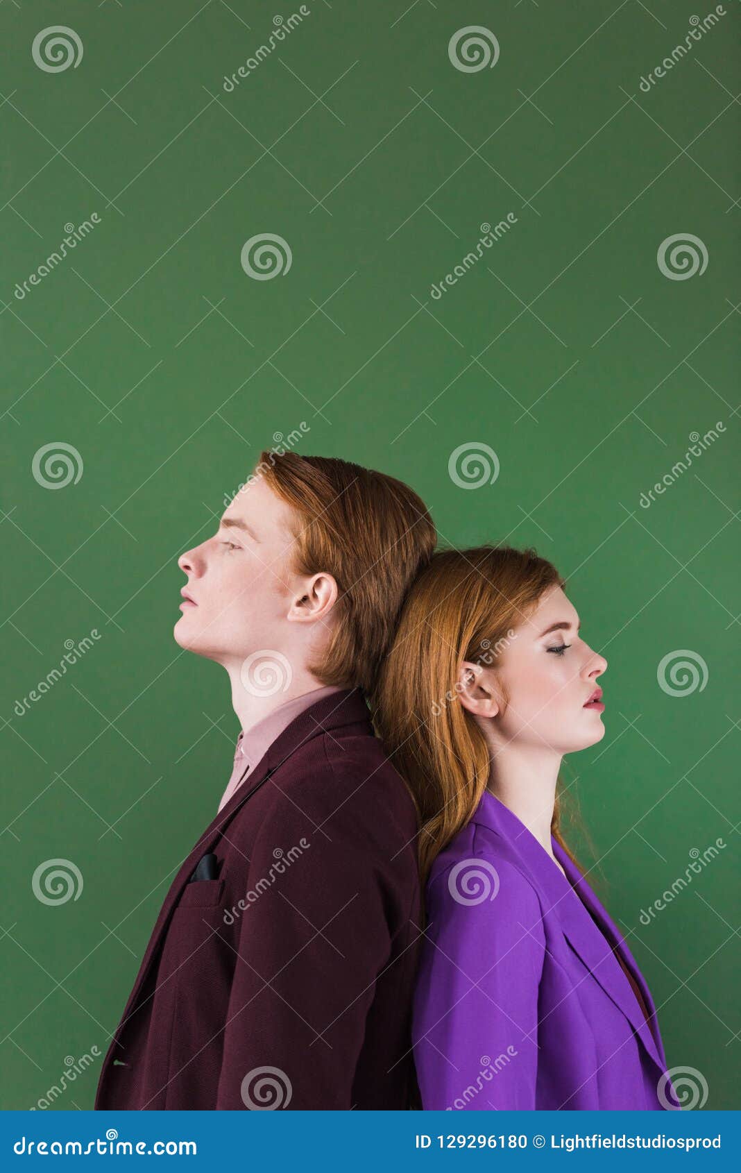 Side View of Stylish Couple of Models Standing Back To Back Stock Photo ...
