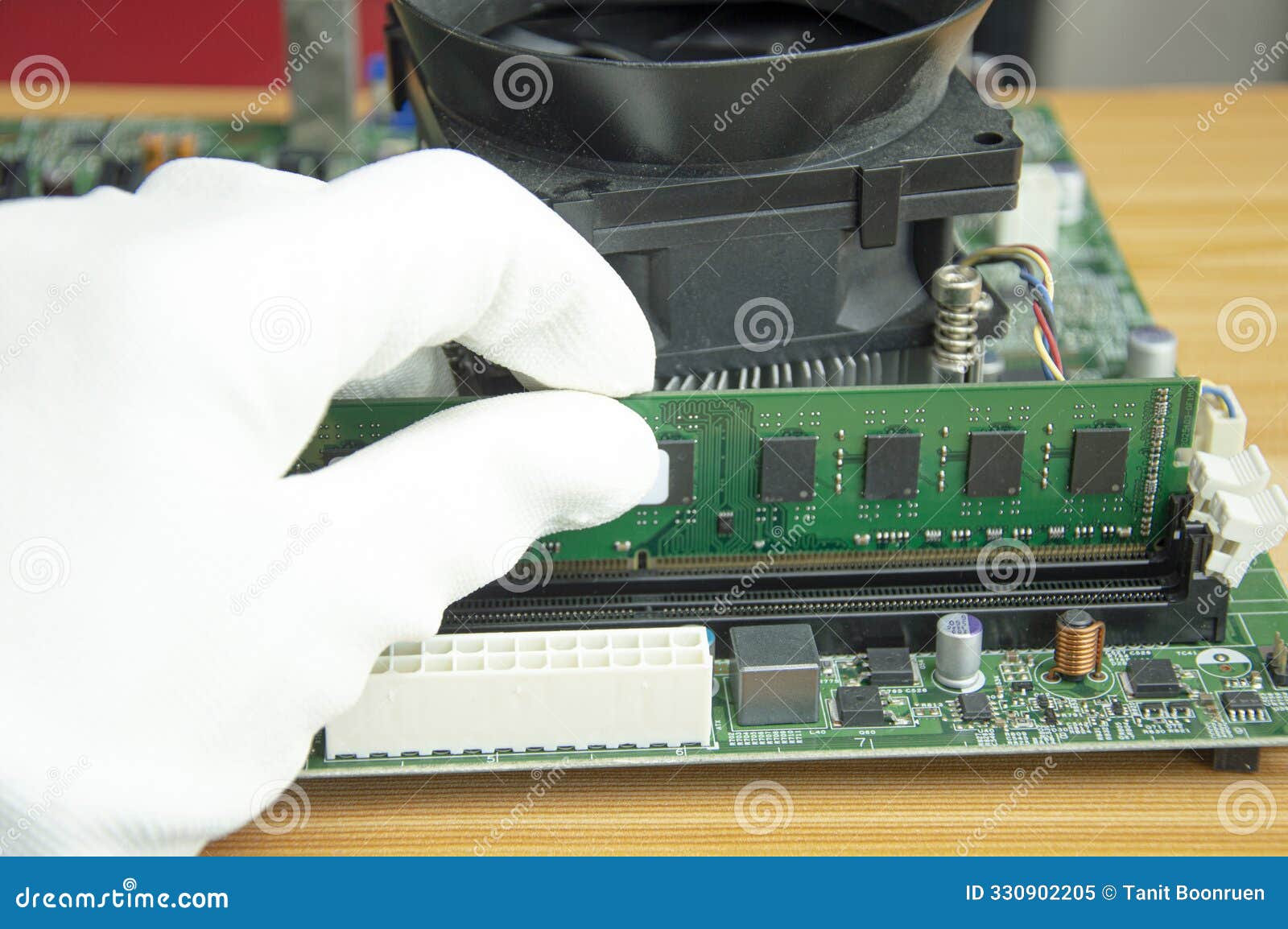 Side View of a Technician Clearing the RAM of a Computer Motherboard ...