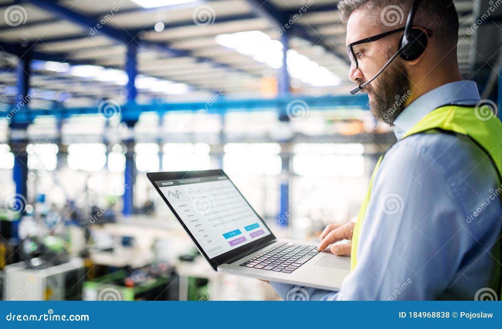 Side View of Technician or Engineer with Headset and Laptop Standing in ...