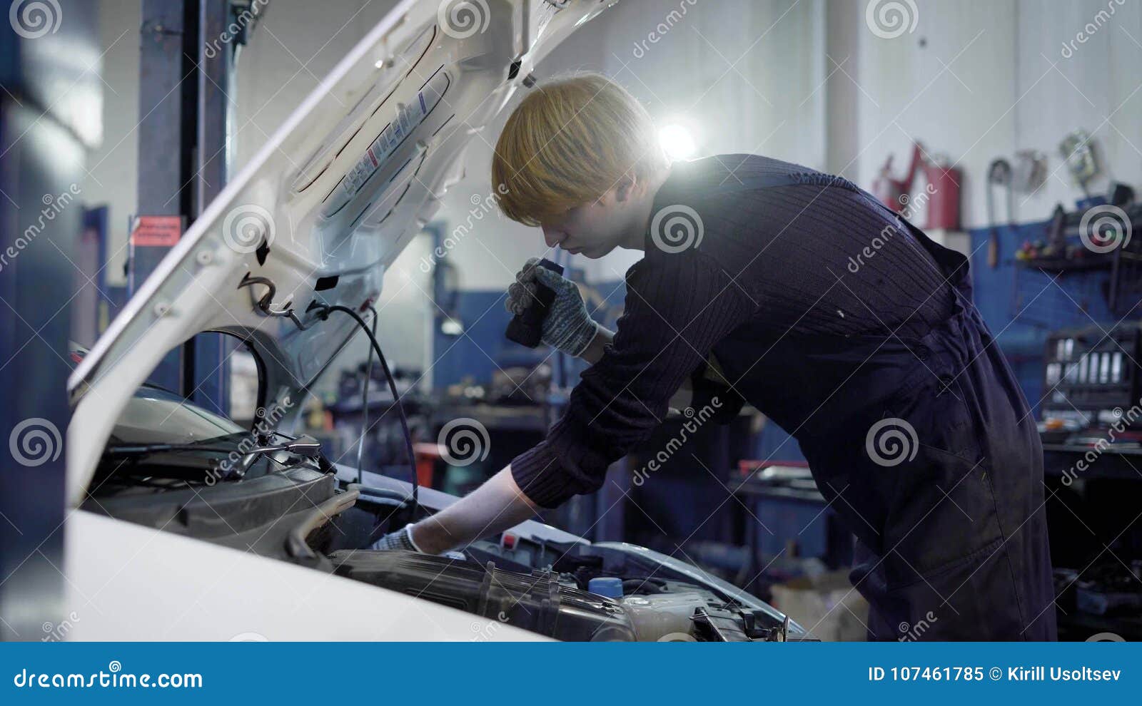 Side View of Technician Making Maintenance of the Car in Garage Stock ...