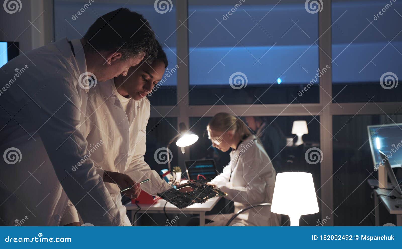 Side View of Two Electronics Development Engineers Talking about ...