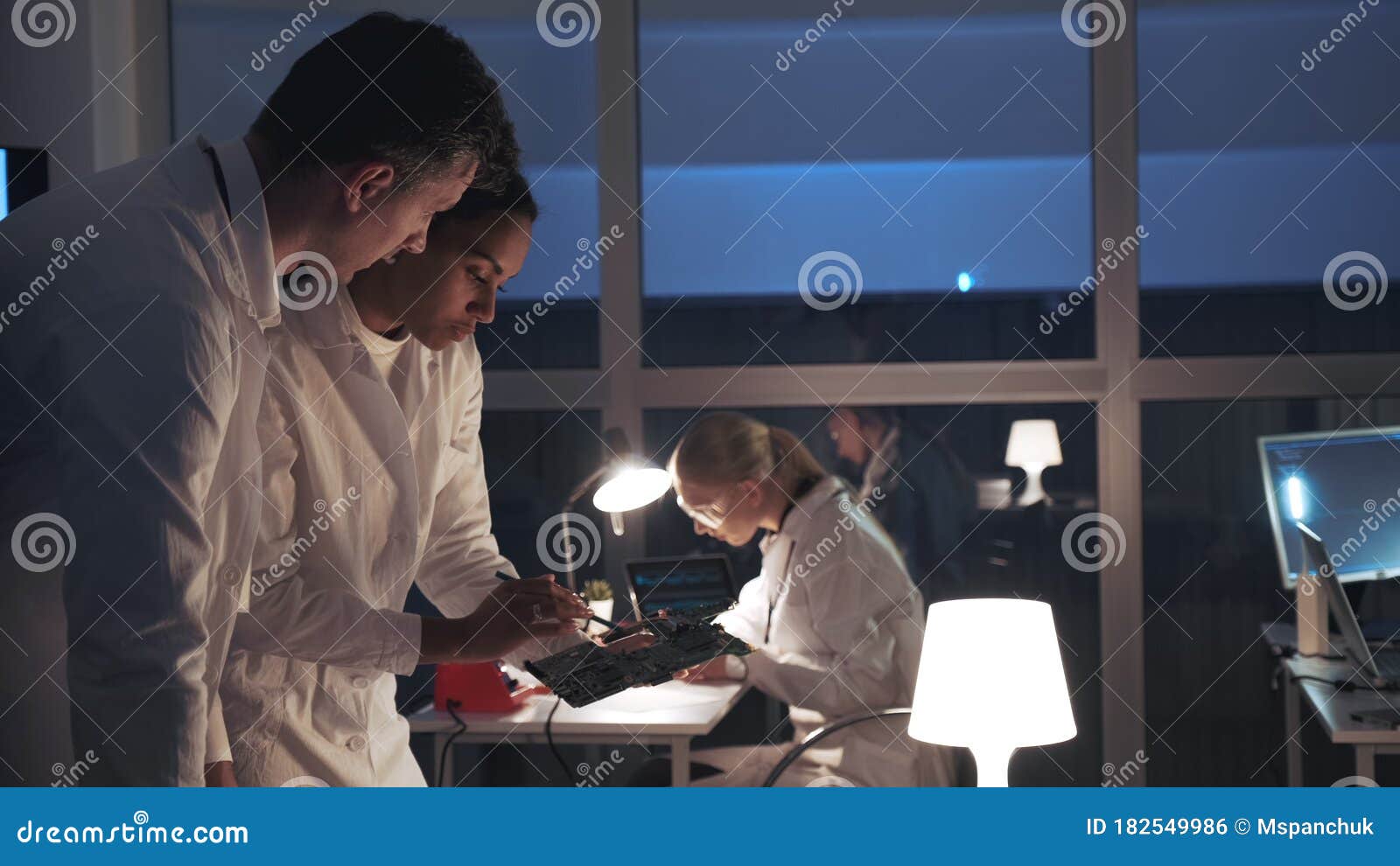 Side View of Two Electronics Development Engineers Talking about ...