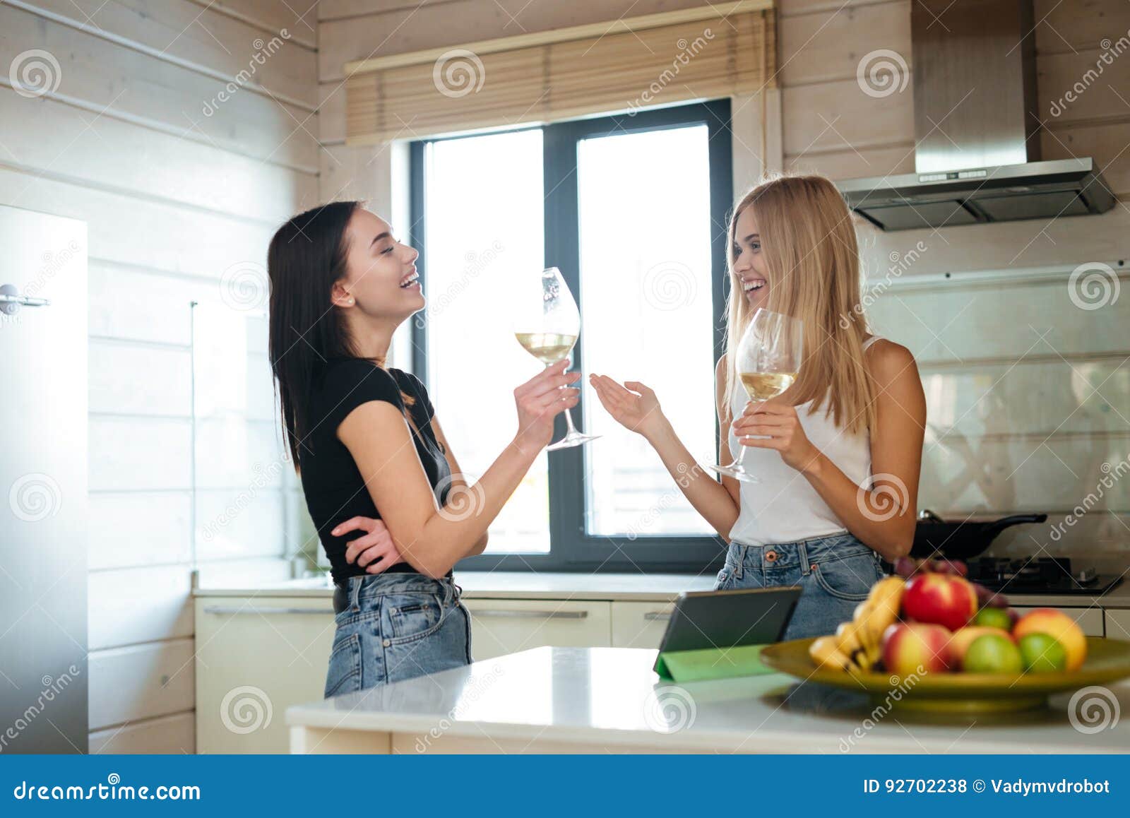 Side View of Two Laughing Women Drinking Wine Stock Photo - Image of ...