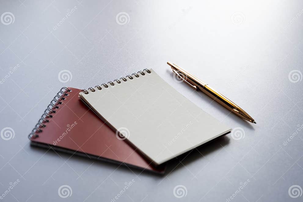 Side View on Two Small Notepads and Golden Pen on the Table Stock Photo ...