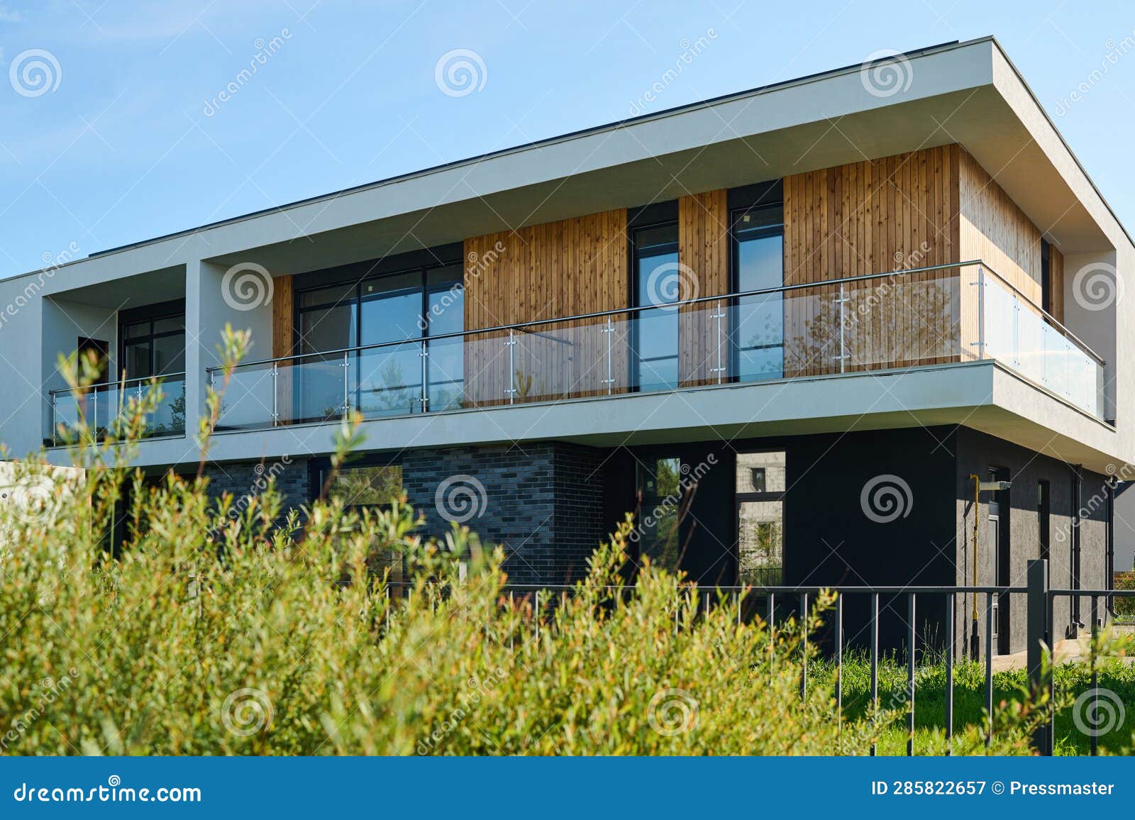 Side View of Two Storey Cottage with Windows and Balcony on Second ...
