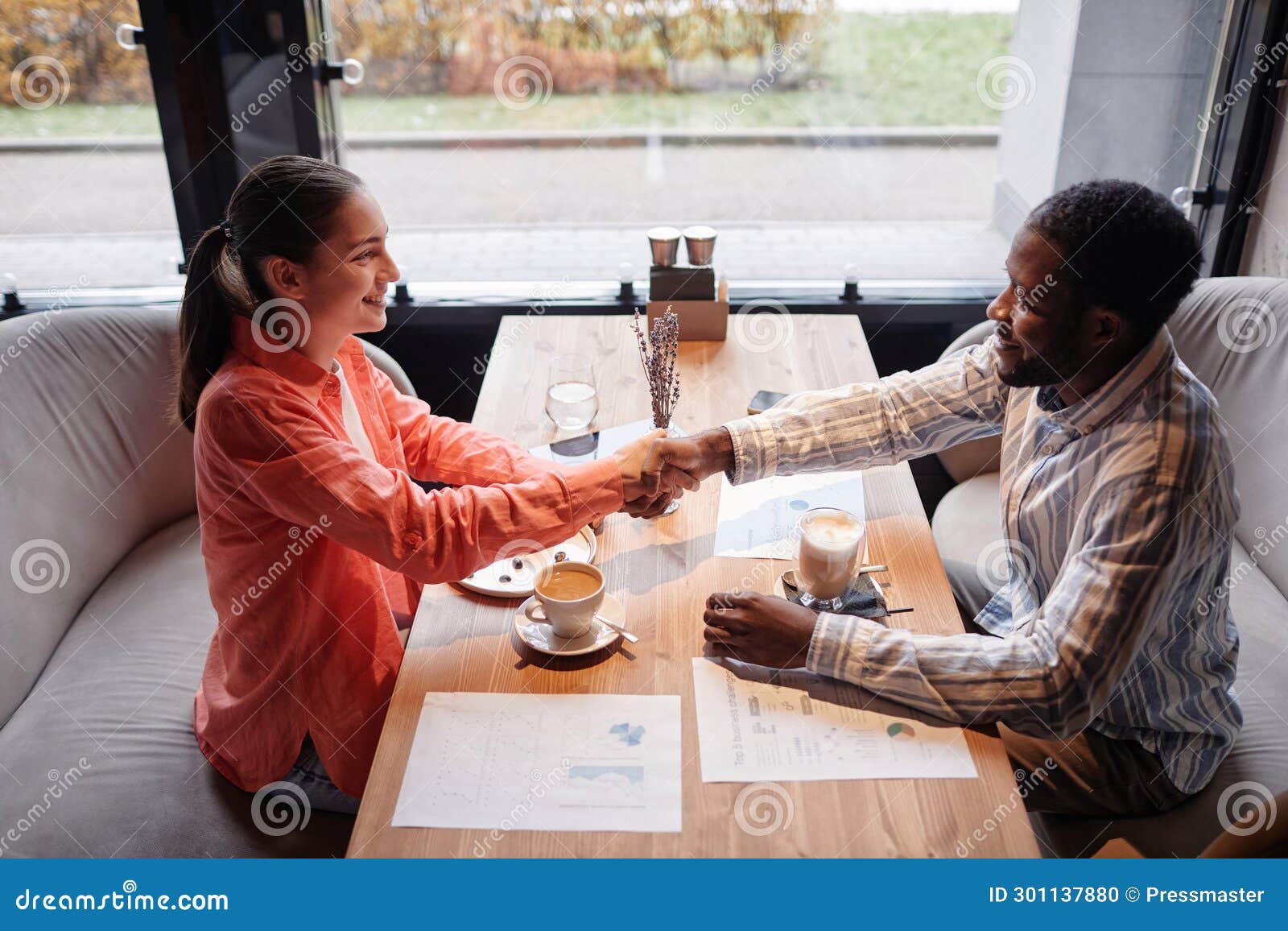 Side View of Two Young Colleagues Greeting One Another by Handshake Stock Photo - Image of happy ...