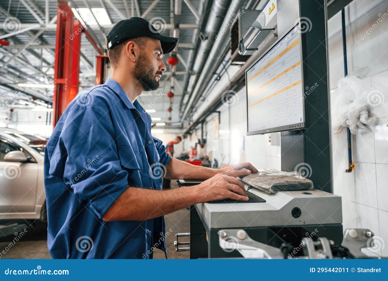 Side View, Using Computer. Auto Mechanic Working in Garage Stock Image ...