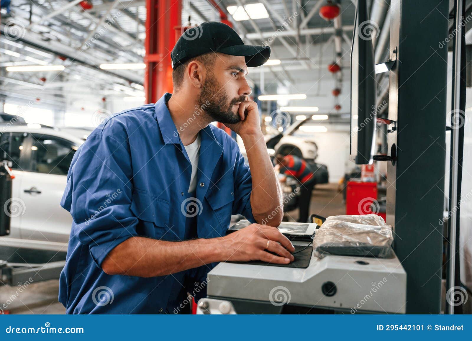 Side View, Using Computer. Auto Mechanic Working in Garage Stock Image ...