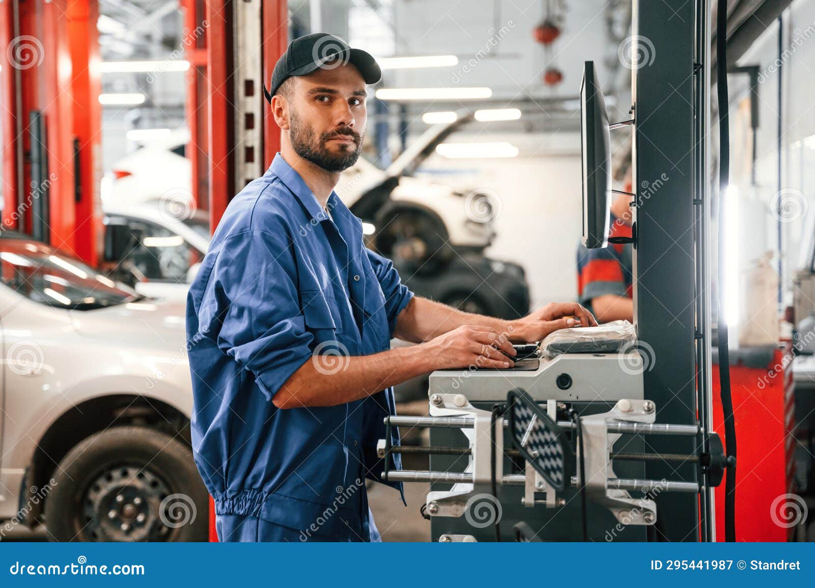 Side View, Using Computer. Auto Mechanic Working in Garage Stock Image ...