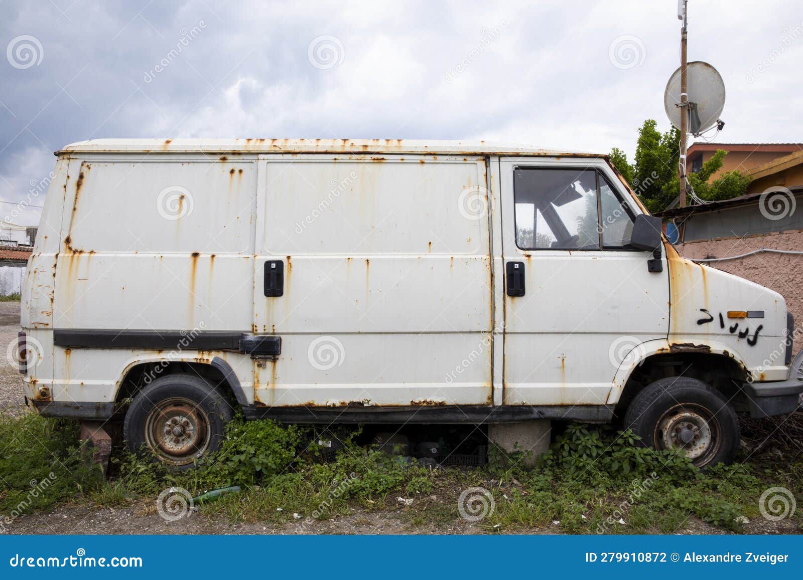 Side View of a Very Old, Rusty, Abandoned Van. it is Off the Ground and ...
