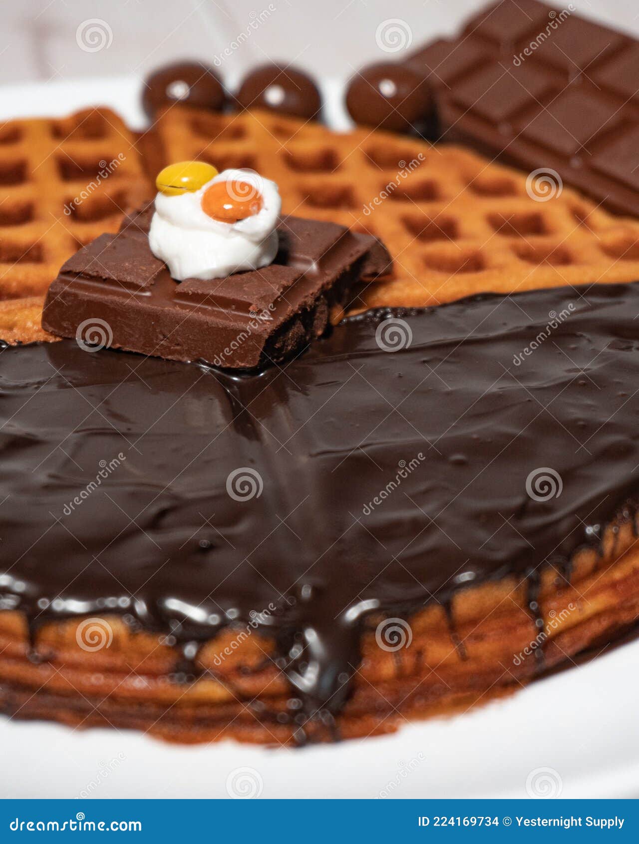 Side View of a Waffle with Chocolate Syrup As the Inside and a Candy As ...