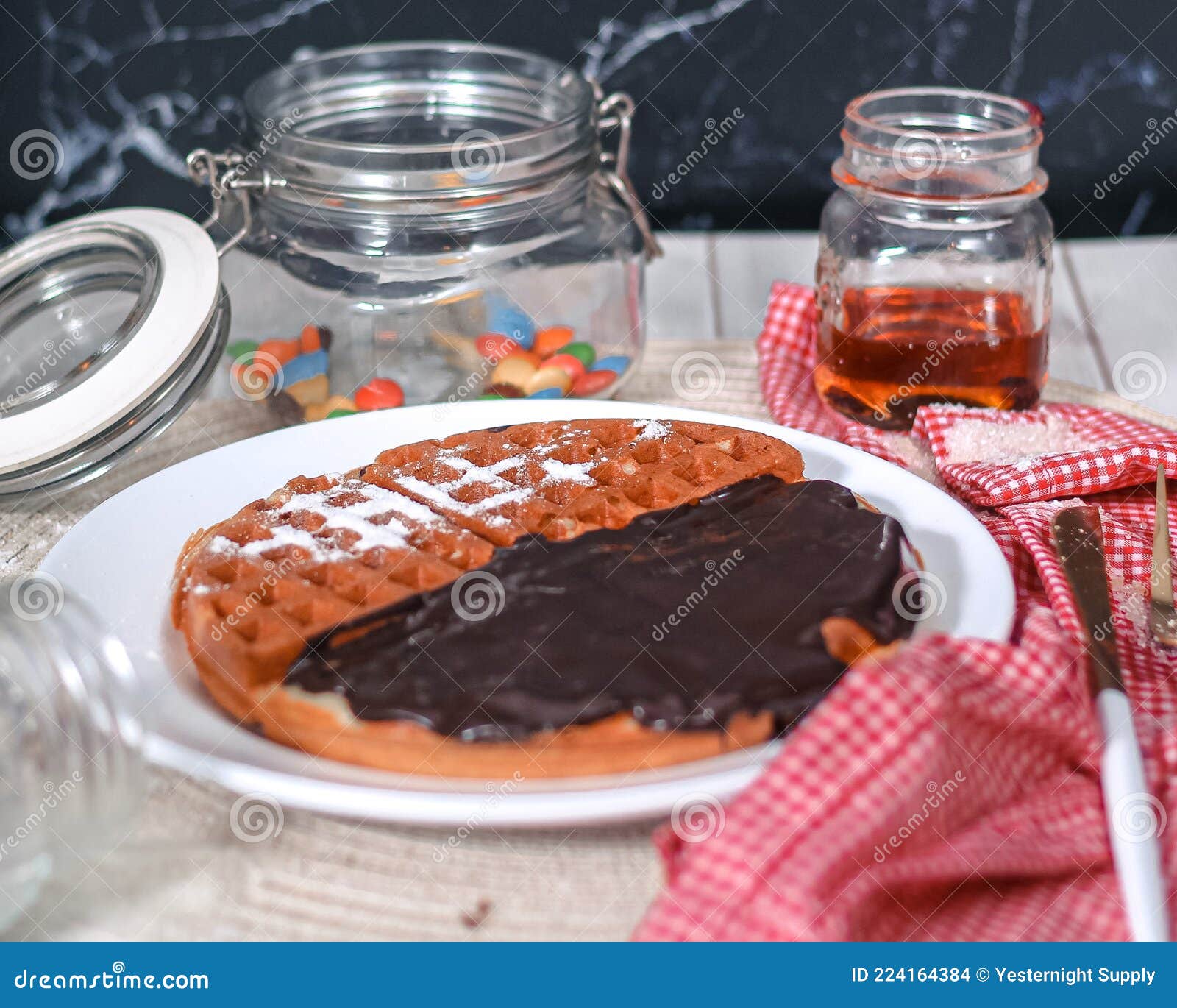 Side View of a Waffle Smeared in a Chocolate Syrup with Sweets on a ...