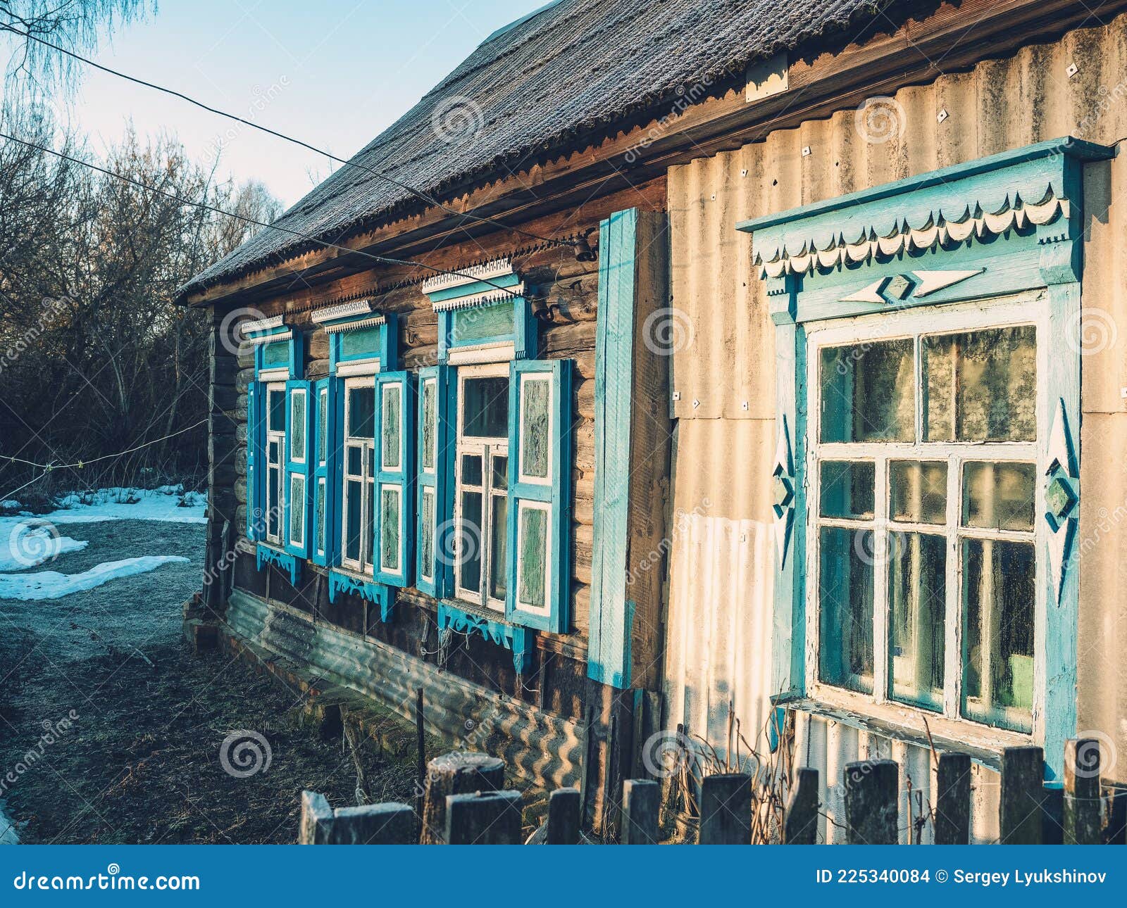 Side View of the Wall of an Old Wooden House with Windows and Blue ...