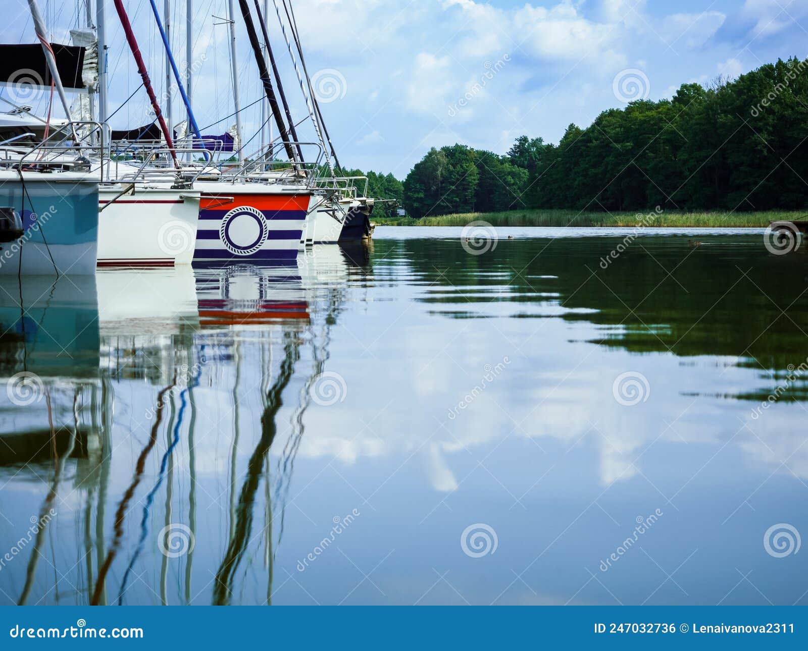 Side View from Water on Moored Sailboats with Reflection in the Lake ...