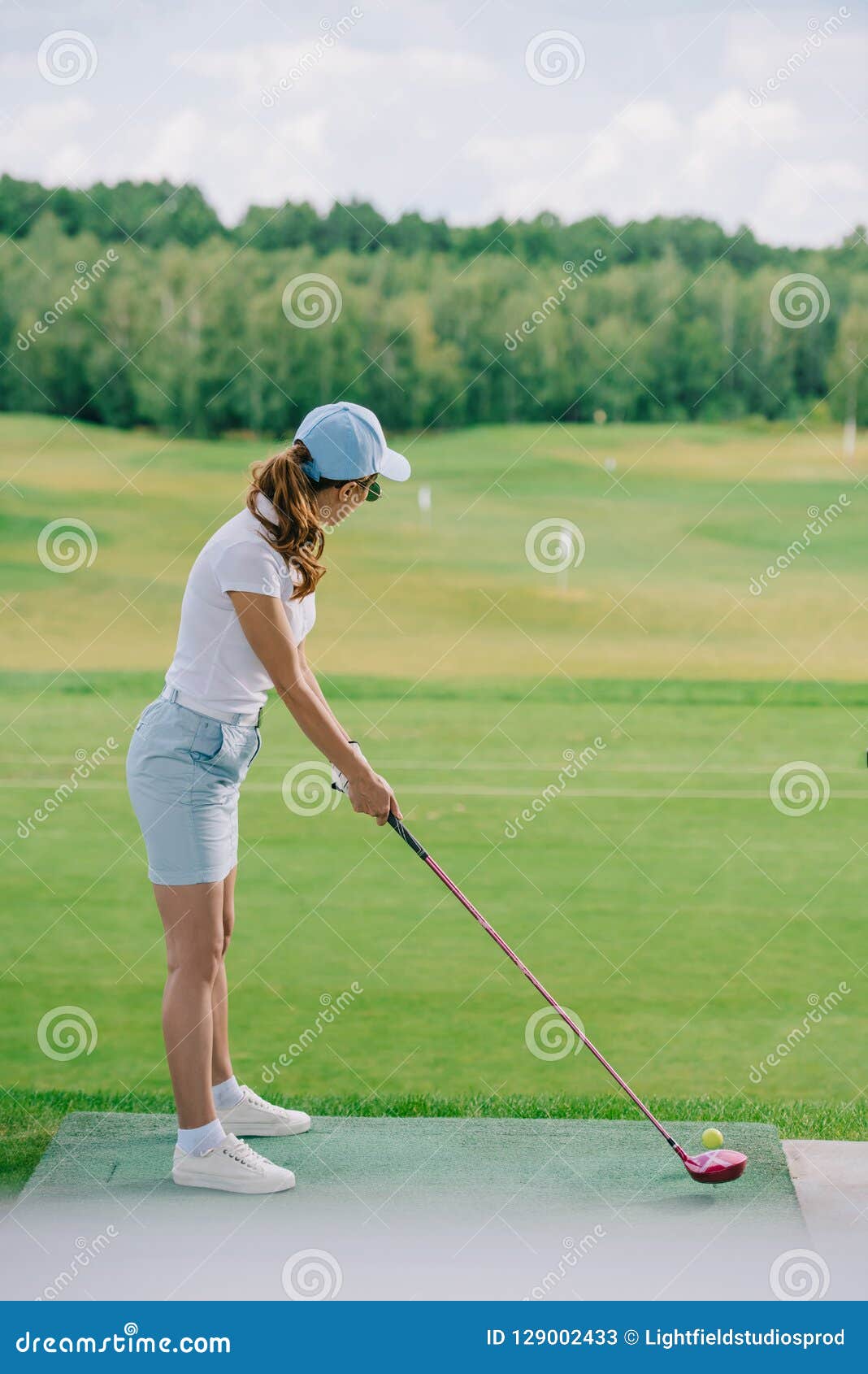 Side View of Woman in Polo and Cap Playing Golf Stock Image - Image of ...