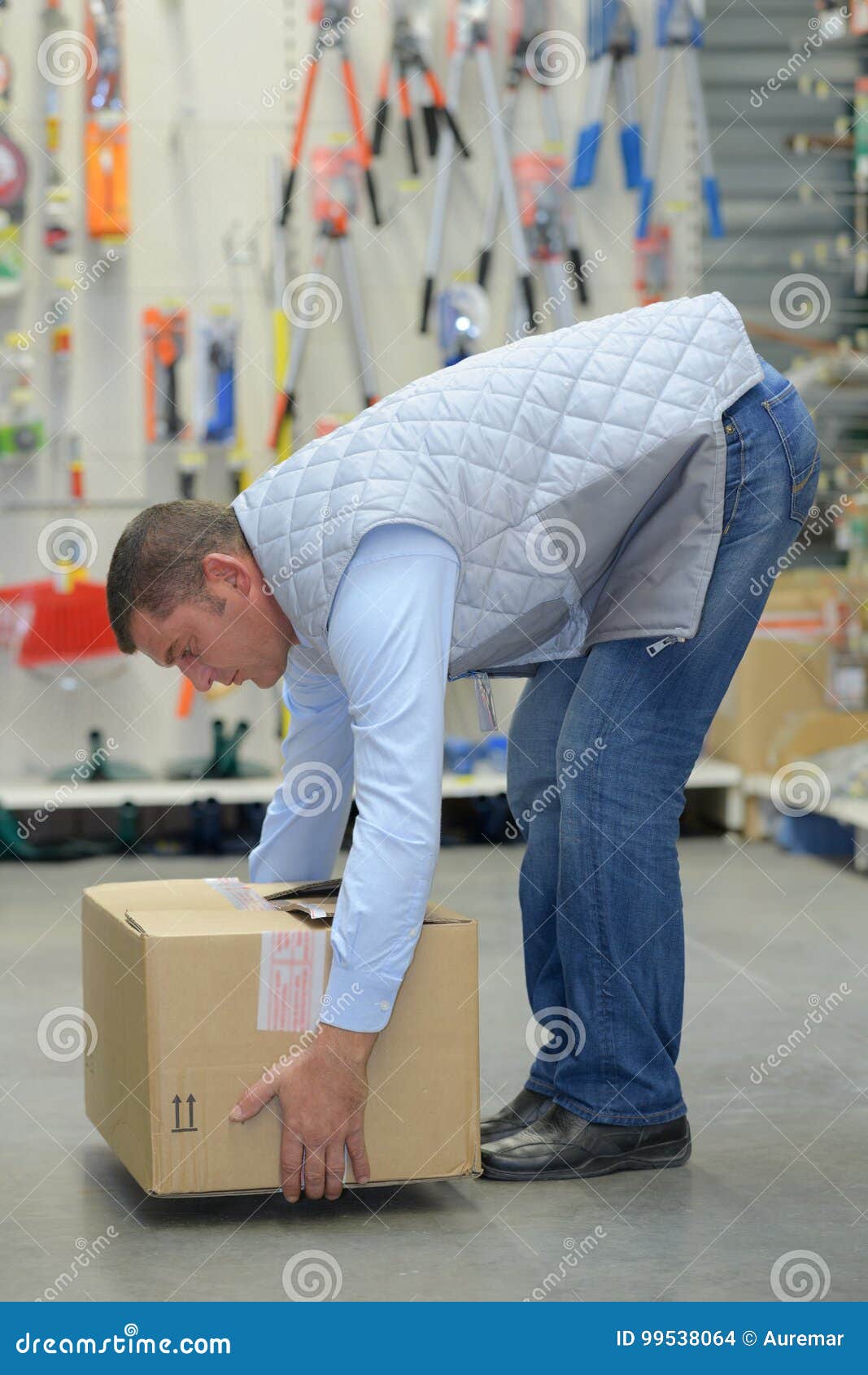 Side View Worker while Lifting Box in Warehouse Stock Photo - Image of ...