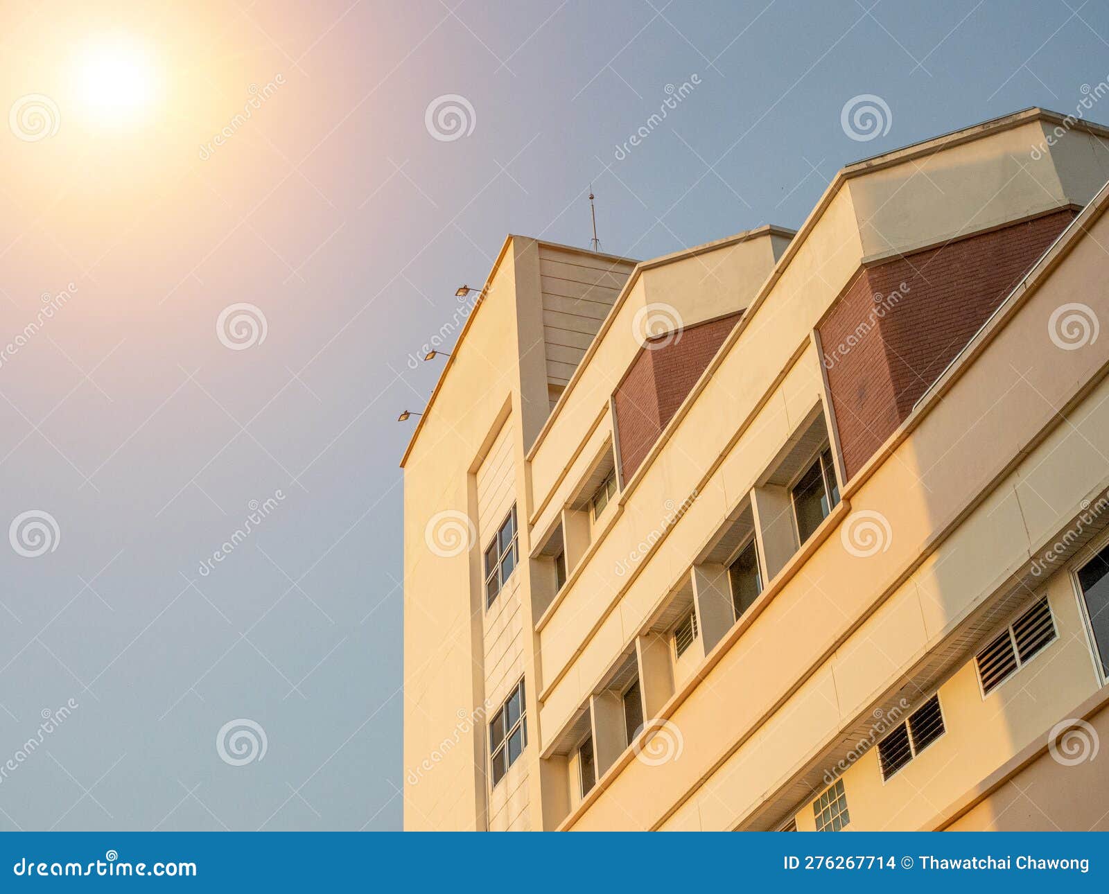 Side View of Yellow Concrete Building Intersect the Orange Sun Stock ...