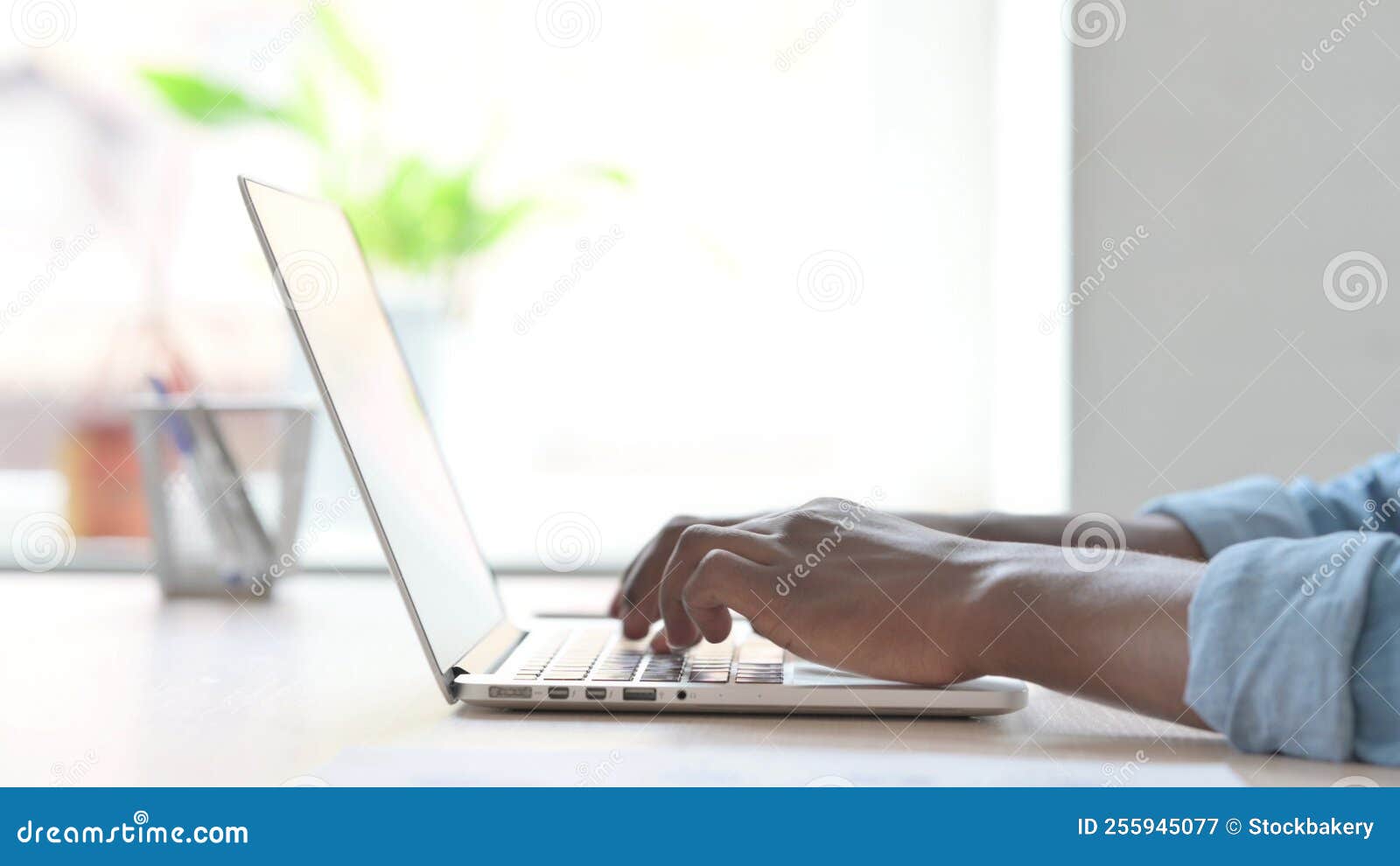 Side View of Young African Man Typing on Laptop Keyboard Stock Image ...