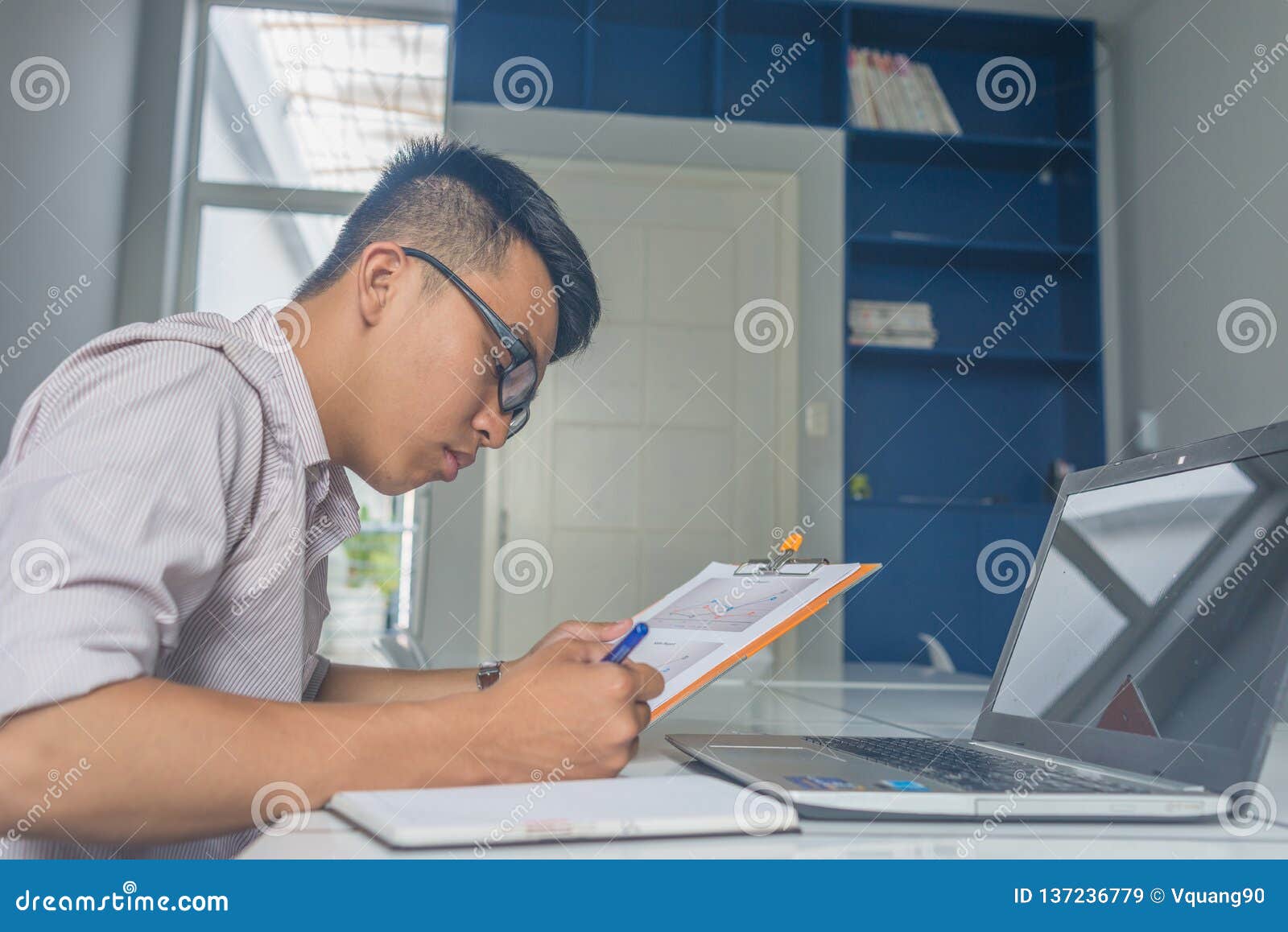 Side View of Young Asian Man Writing Note into the Notebook Stock Image ...