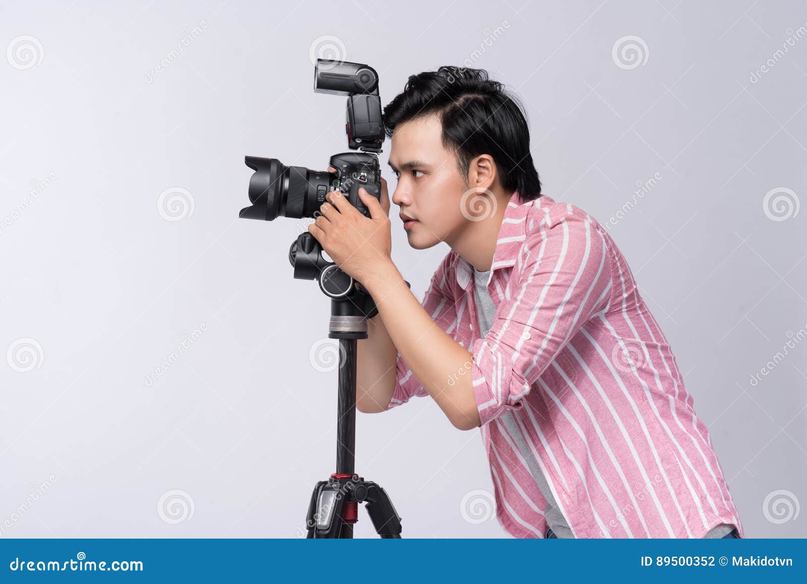 Side View of Young Asian Photographer Holding Digital Camera, while ...
