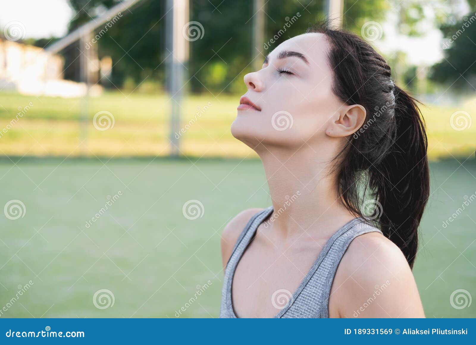 Side View Of Young Beautiful Female With Closed Eyes Breathing Deeply