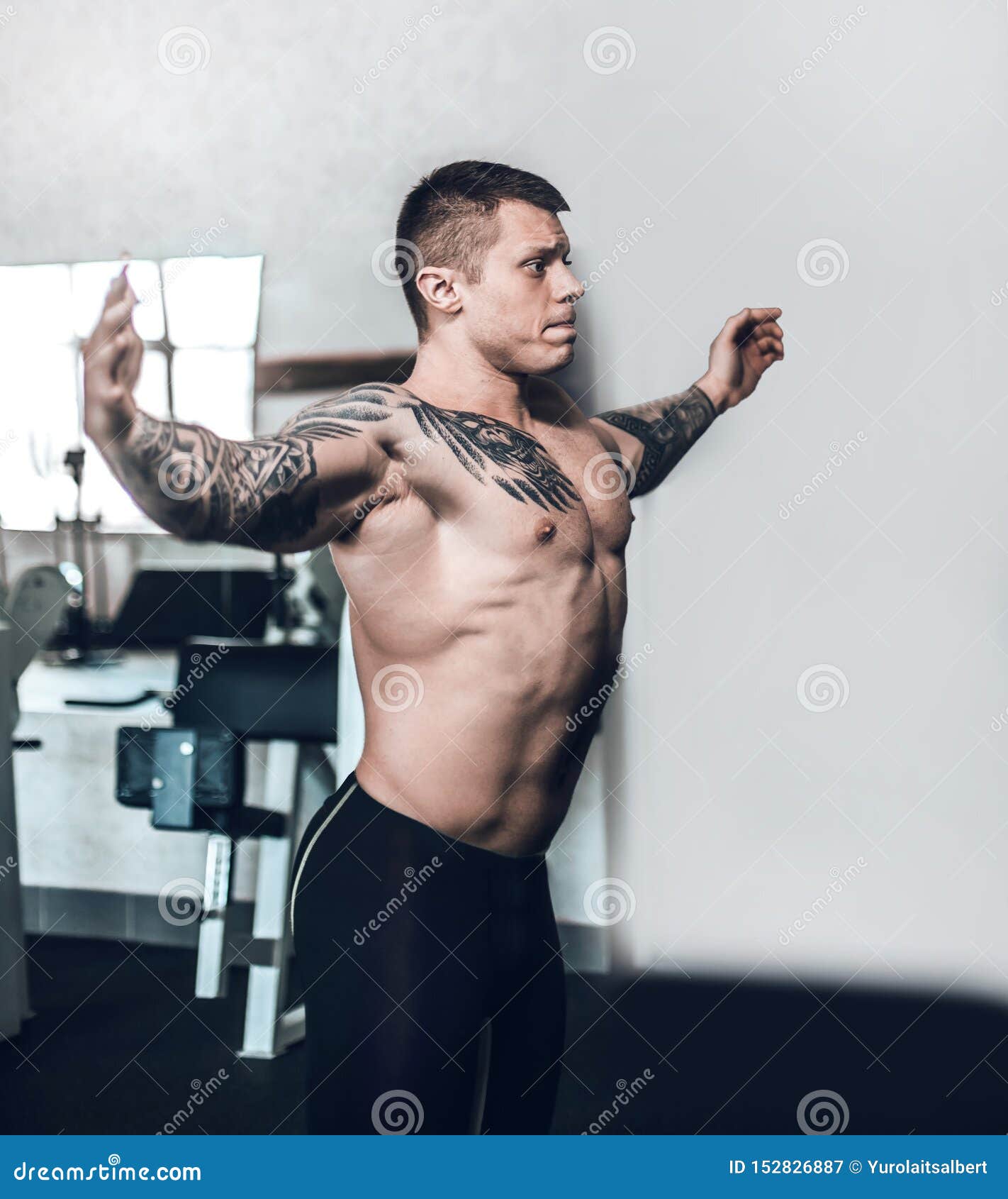 Side View. Young Bodybuilder Posing in Gym Stock Image - Image of ...