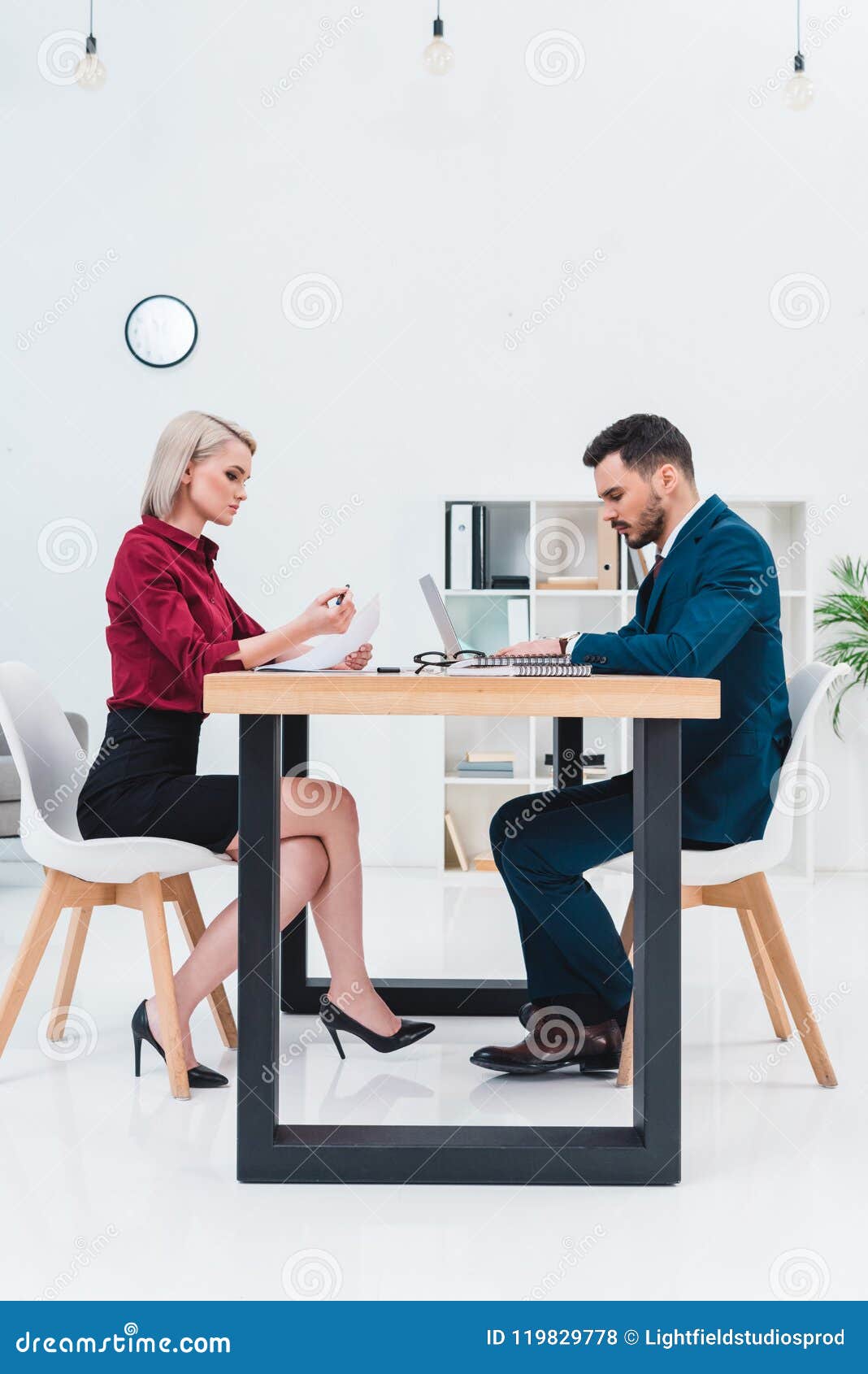 Side View of Young Business Colleagues Working Together Stock Photo ... Side View of Young Business Colleagues Working Together Stock Photo ...