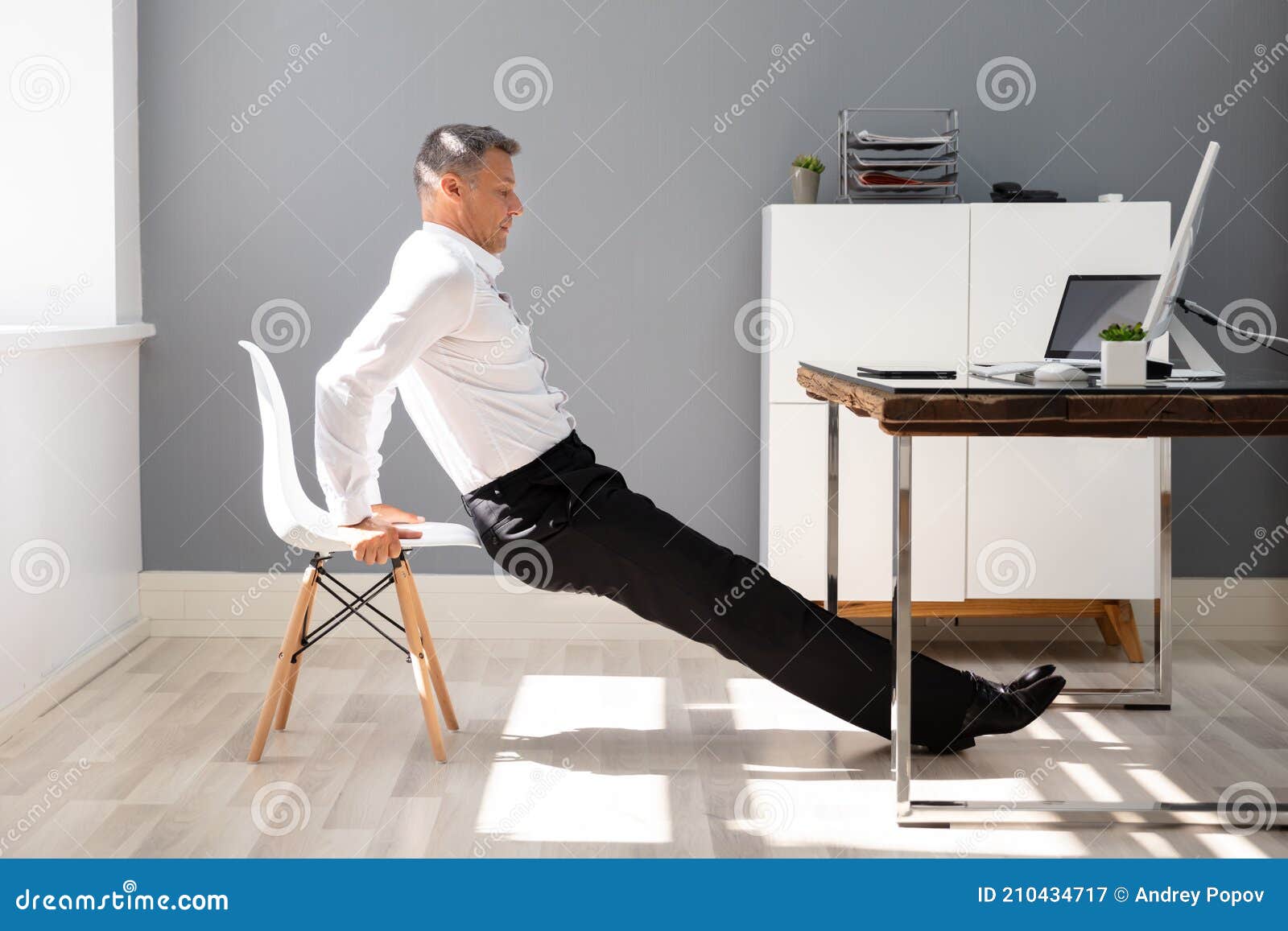 Businessman Doing Triceps Dips in Office Stock Image - Image of desk ...
