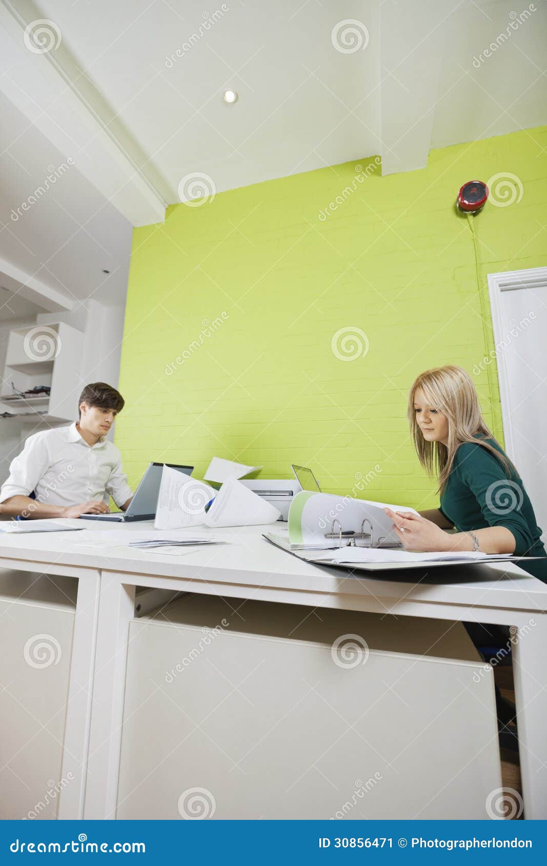 Side View of Young Businesspeople Busy Working at Desk Stock Image ...