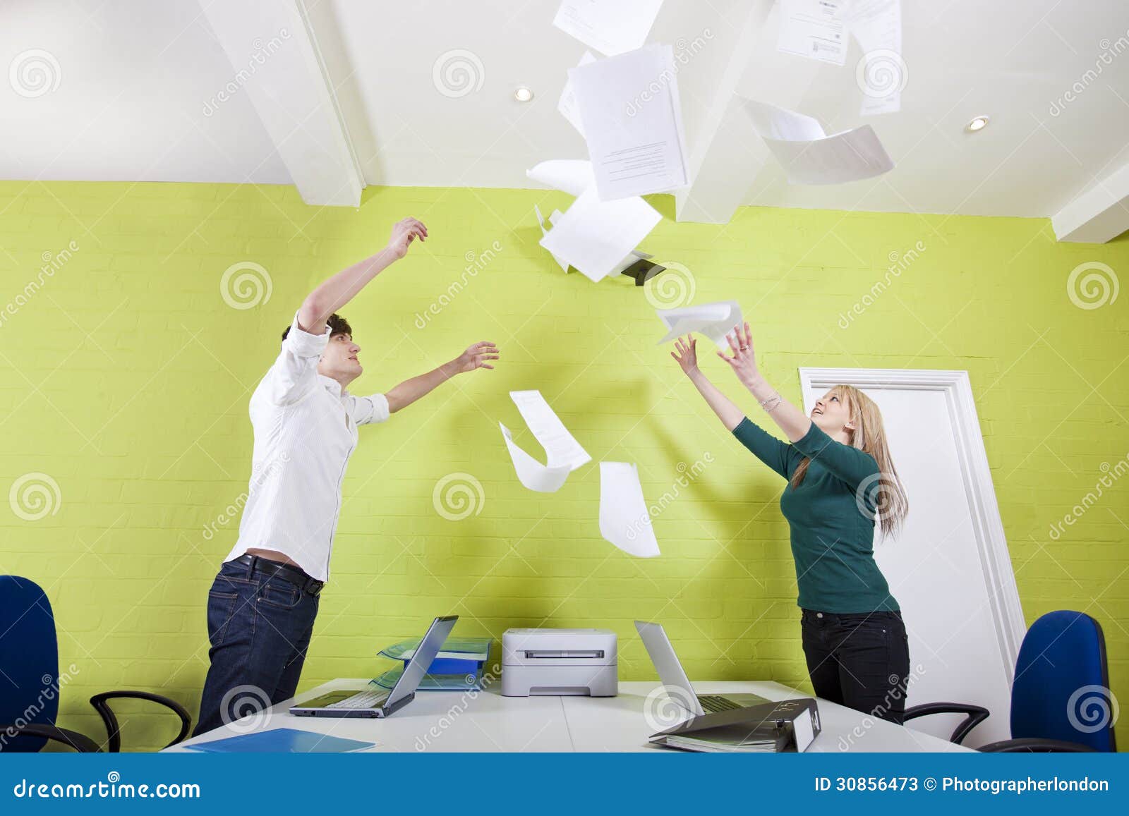 Side View of Young Businesspeople Throwing Documents in Office Stock ...