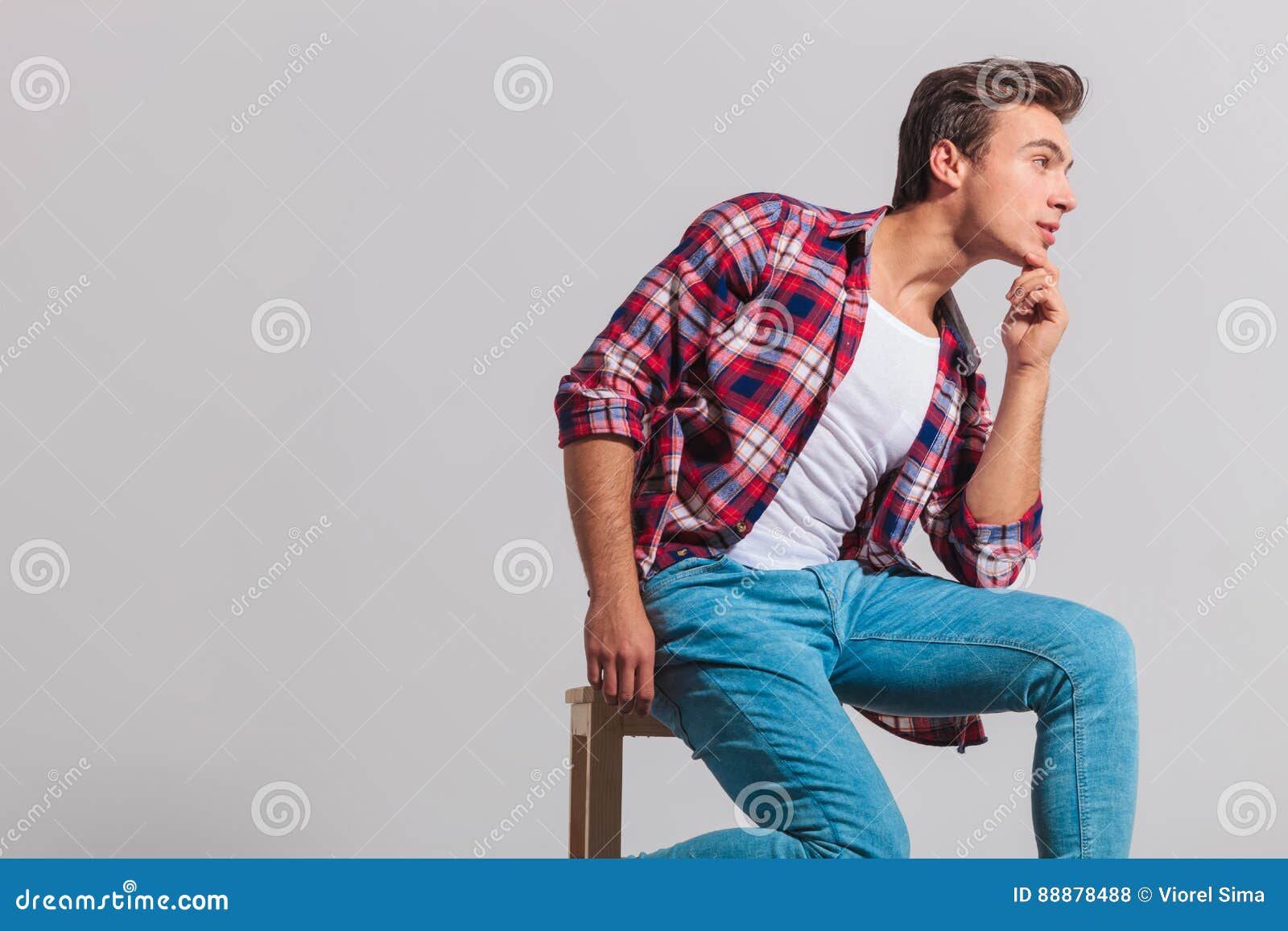Side View of a Young Casual Man Thinking while Sitting Stock Photo ...