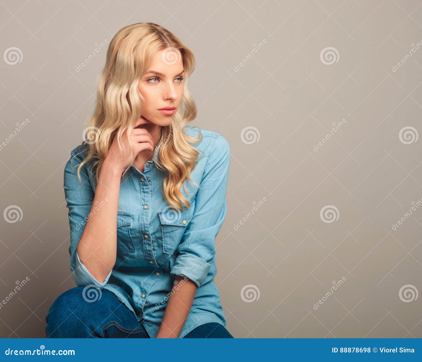 Side View of a Young Casual Woman Sitting Stock Photo - Image of blue ...