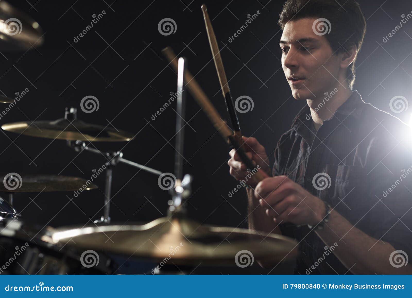 Side View of Young Drummer Playing Drum Kit in Studio Stock Photo ...