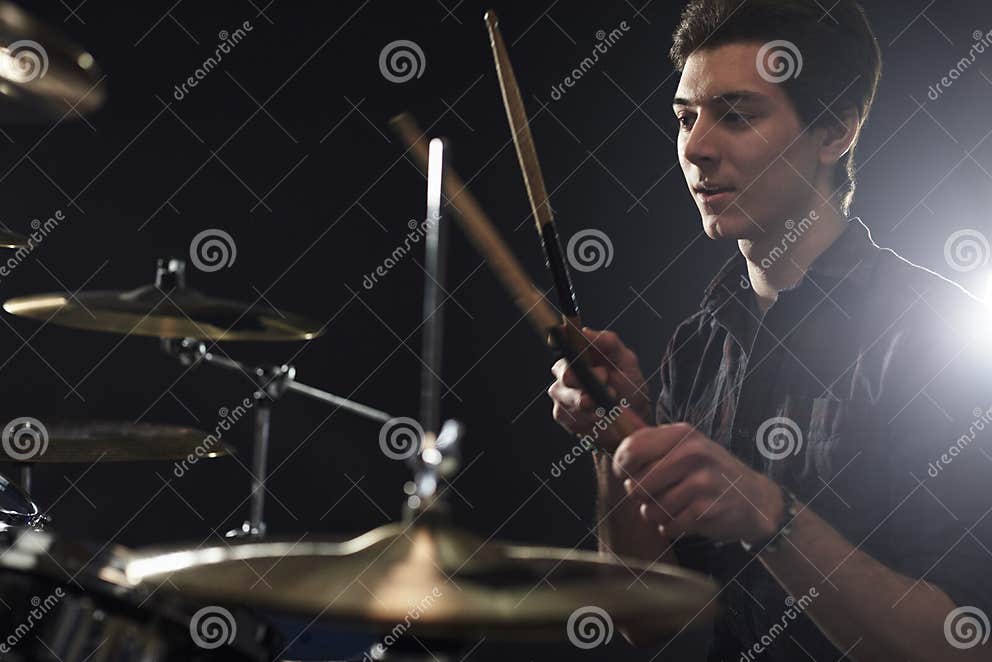 Side View of Young Drummer Playing Drum Kit in Studio Stock Photo ...