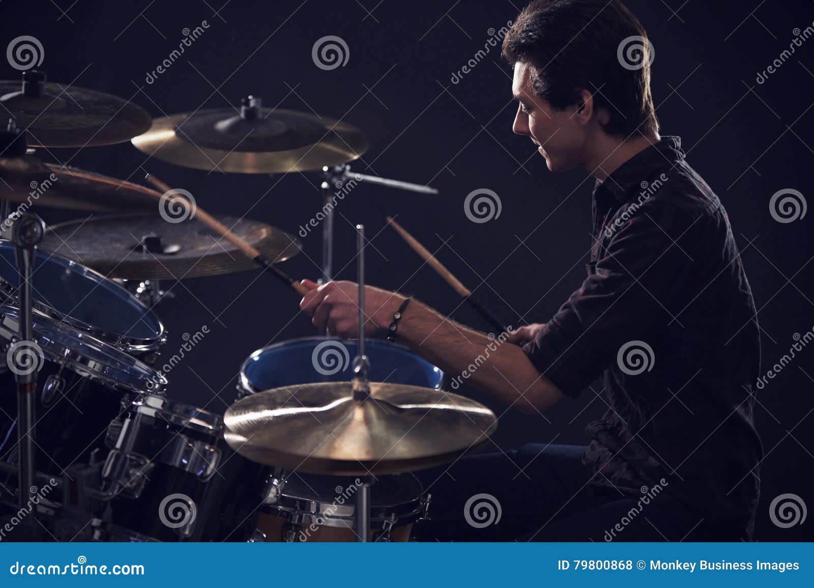 Side View of Young Drummer Playing Drum Kit in Studio Stock Photo ...