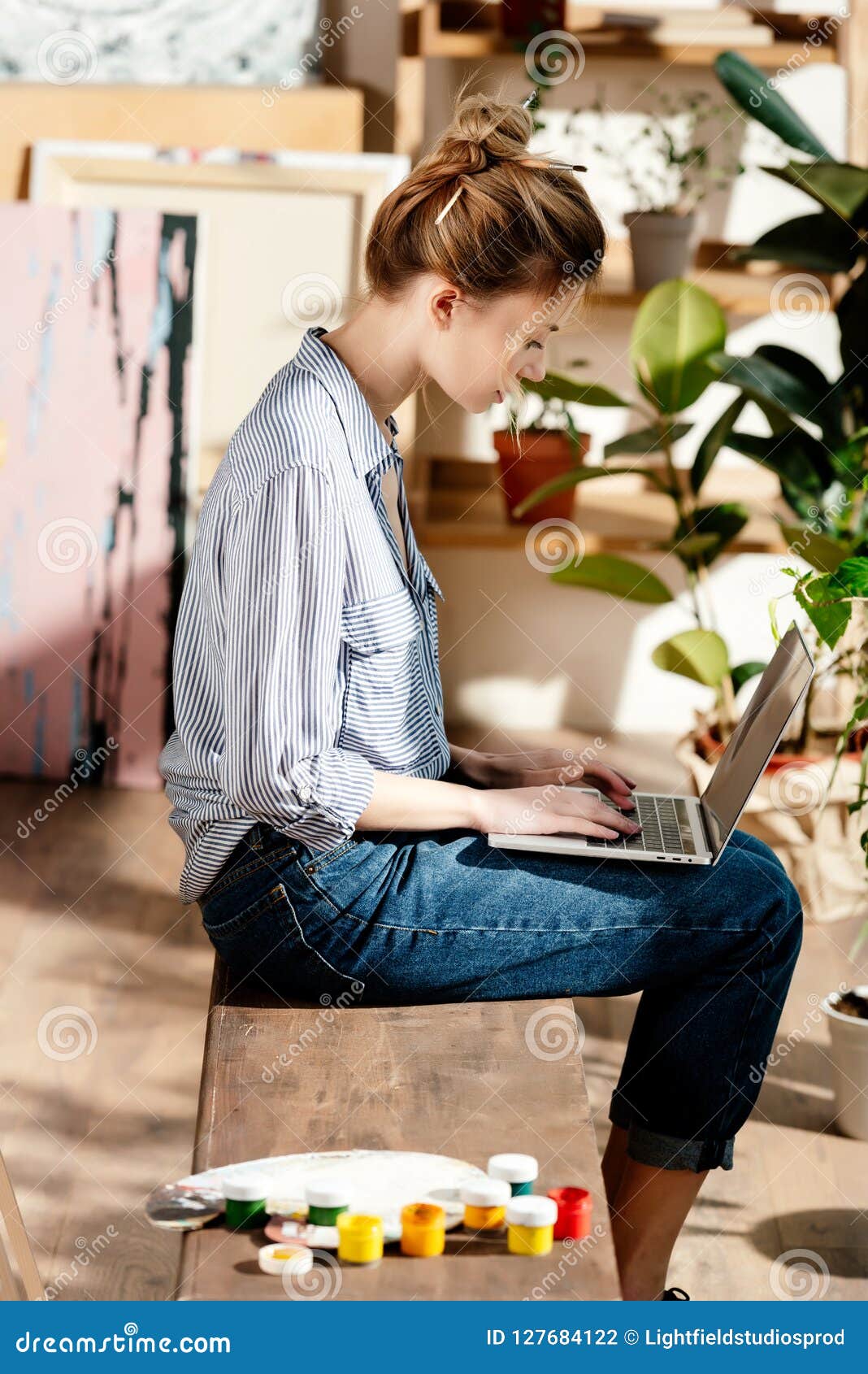 Side View of Young Female Artist Sitting on Bench with Paints Stock ... Side View of Young Female Artist Sitting on Bench with Paints Stock ...