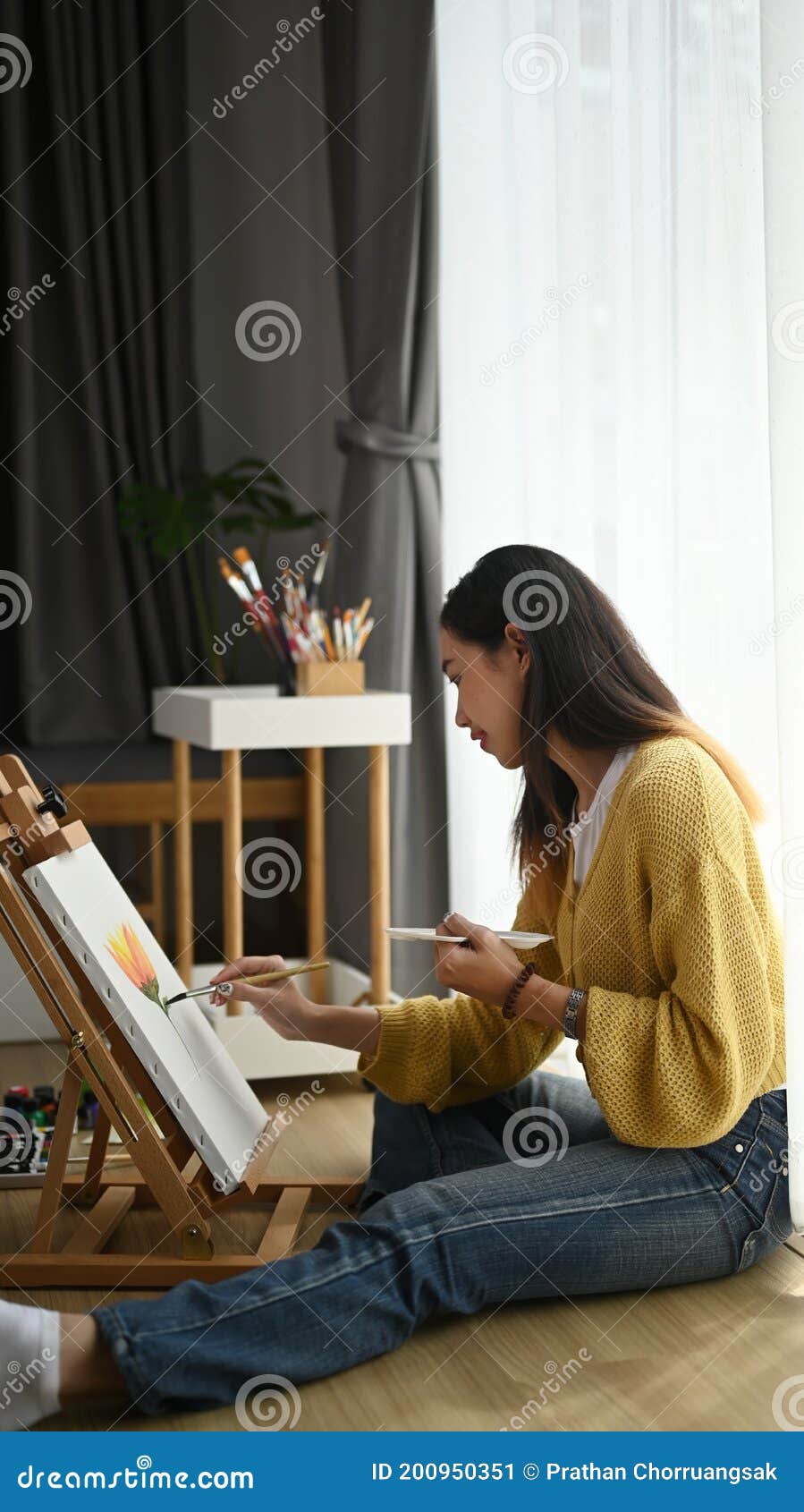 Side View of a Young Female Painter Painting in Her Workshop. Stock ...