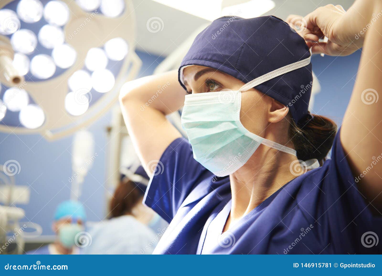 Side View of Young Female Surgeon Tying Her Surgical Mask Stock Image ... Side View of Young Female Surgeon Tying Her Surgical Mask Stock Image ...