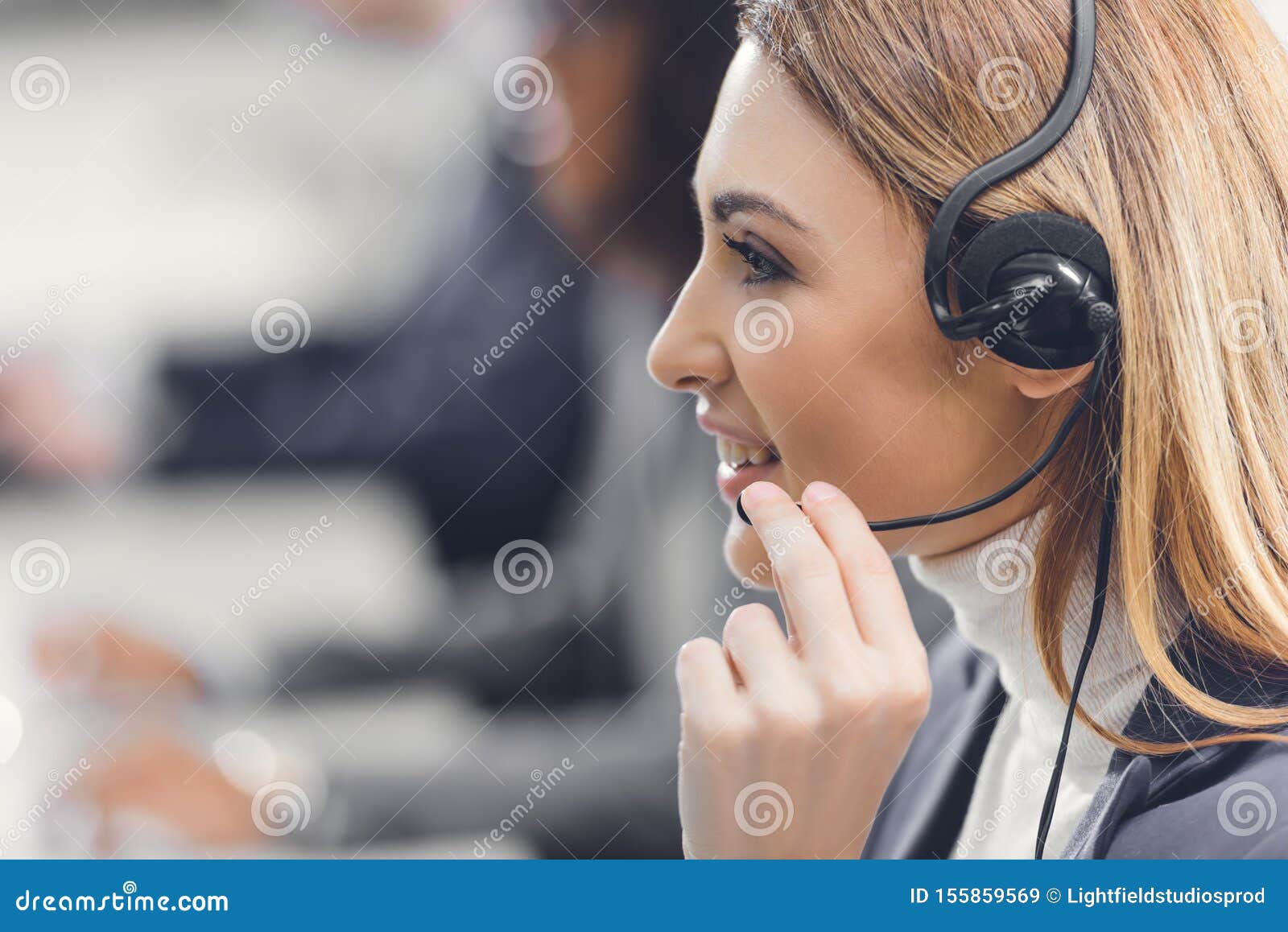 Side View of Young Female Teleworker in Headset Smiling and Working ...