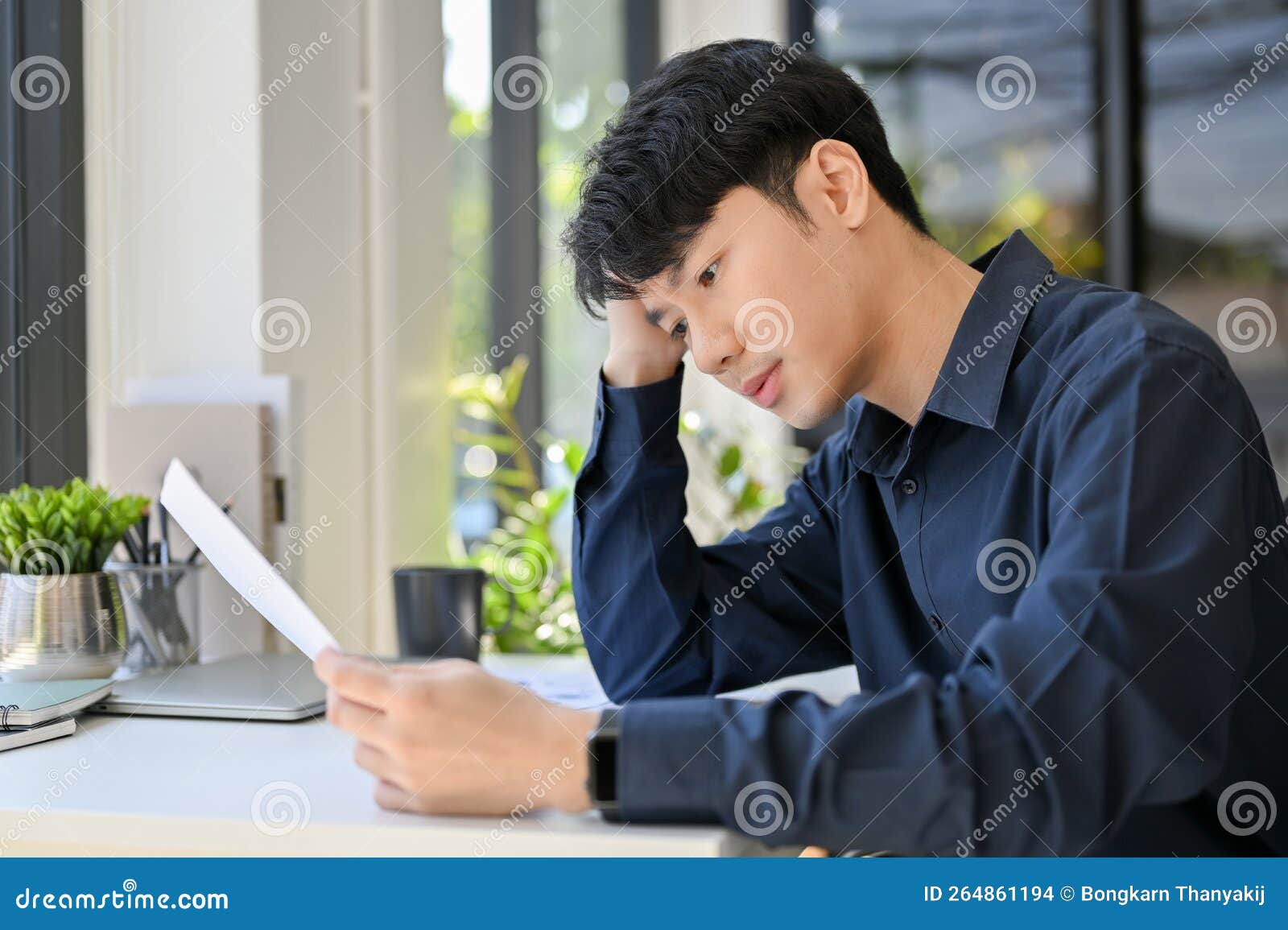 Young Handsome Businessman Concentrate on His Document while Working on ...