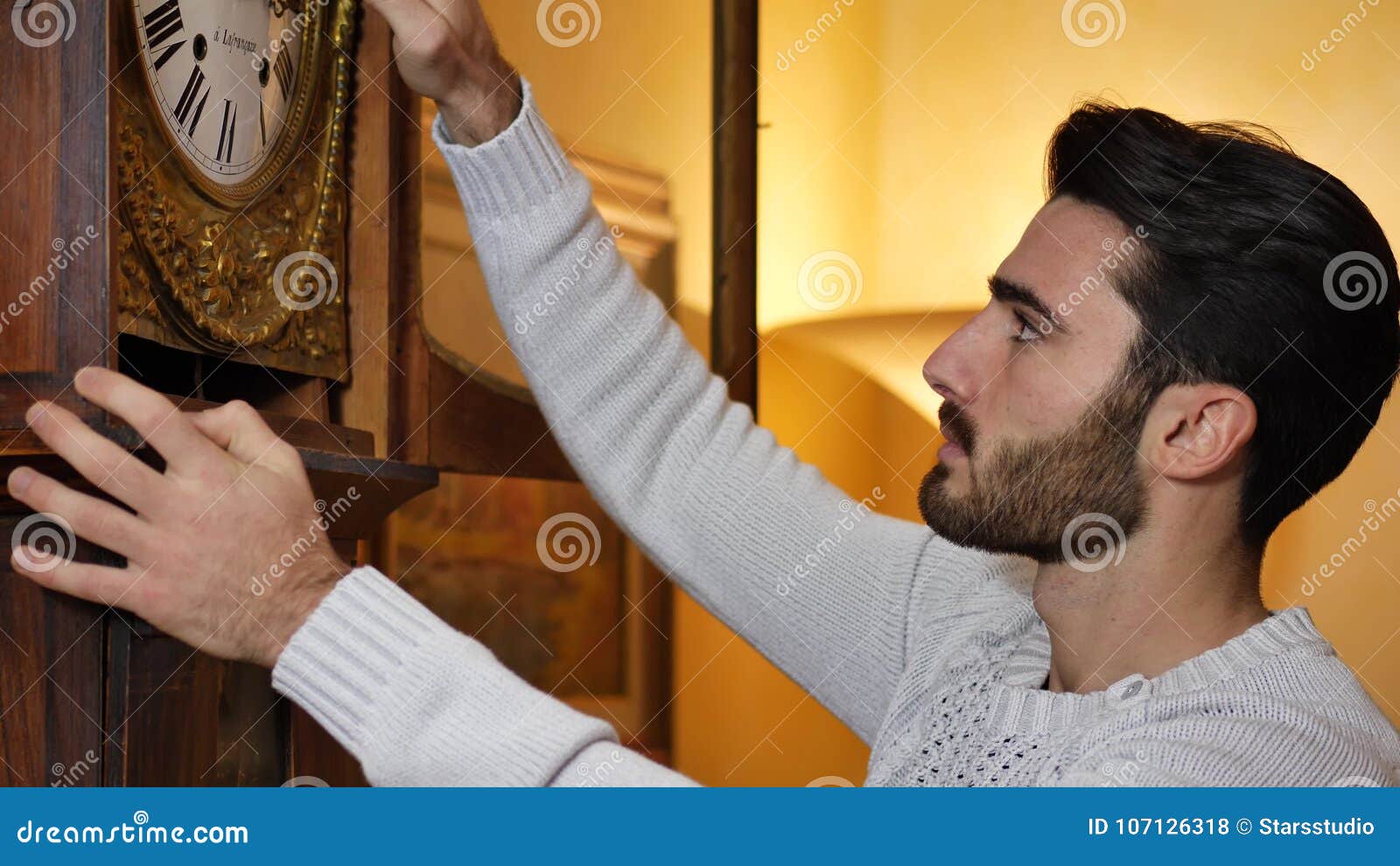 Young man setting clock stock footage. Video of aged - 107126318