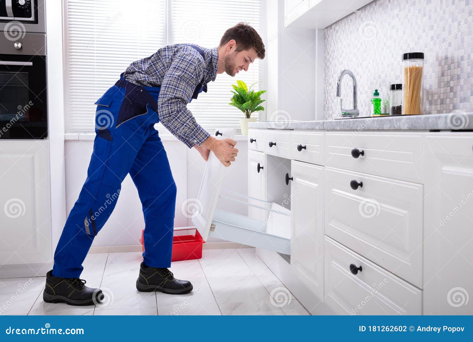 Handyman Installing Drawer in Kitchen Stock Photo - Image of holding ...