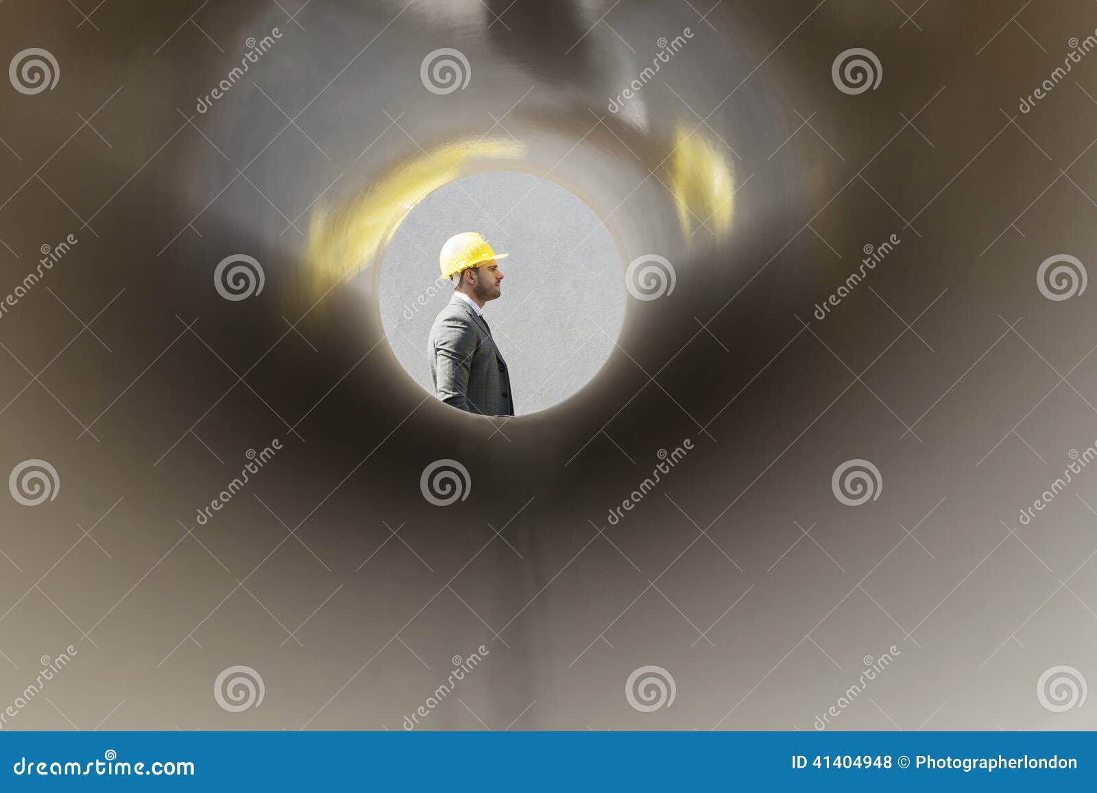 Side View of Young Male Architect through Large Pipe at Construction ...