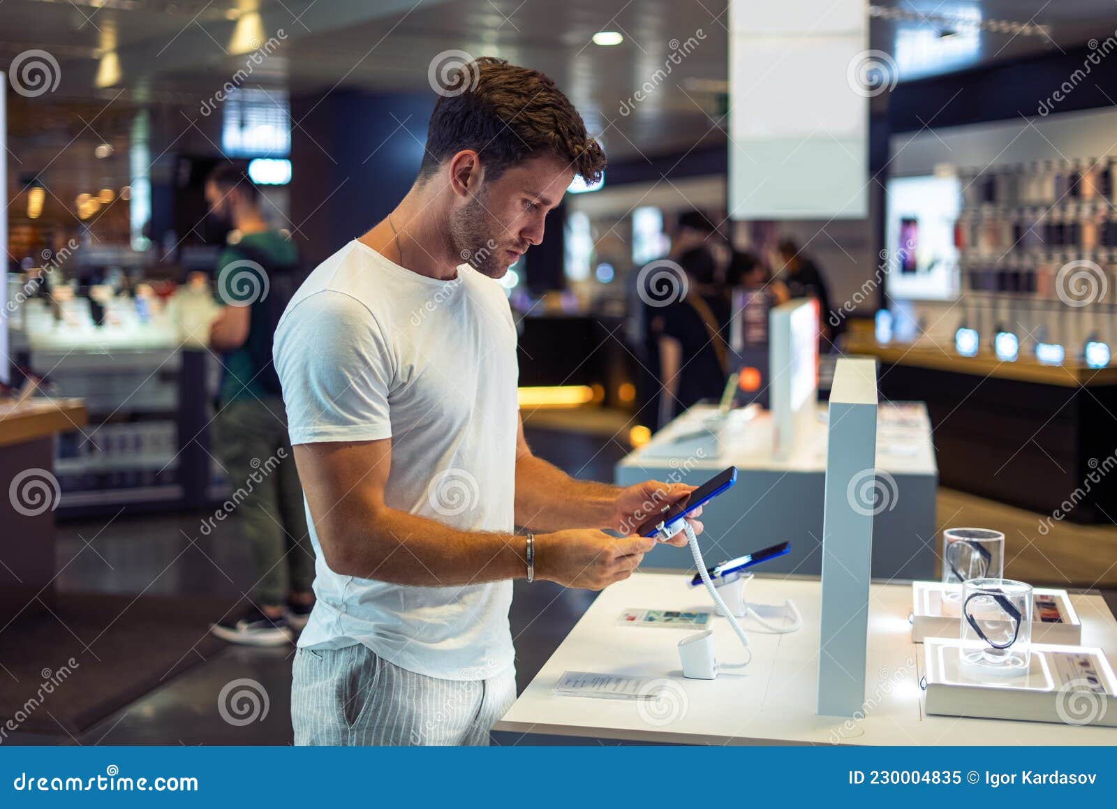 Young Man Buying Gadget in Store Stock Image - Image of check, market ...