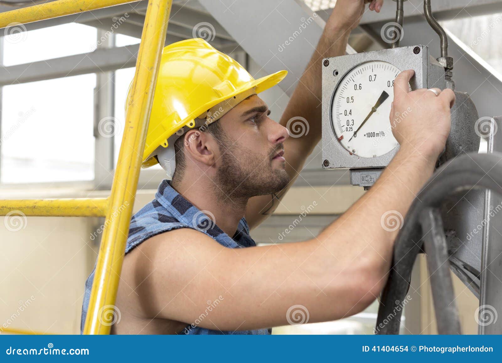 Side View of Young Male Worker Checking Pressure Gauge in Industry ...