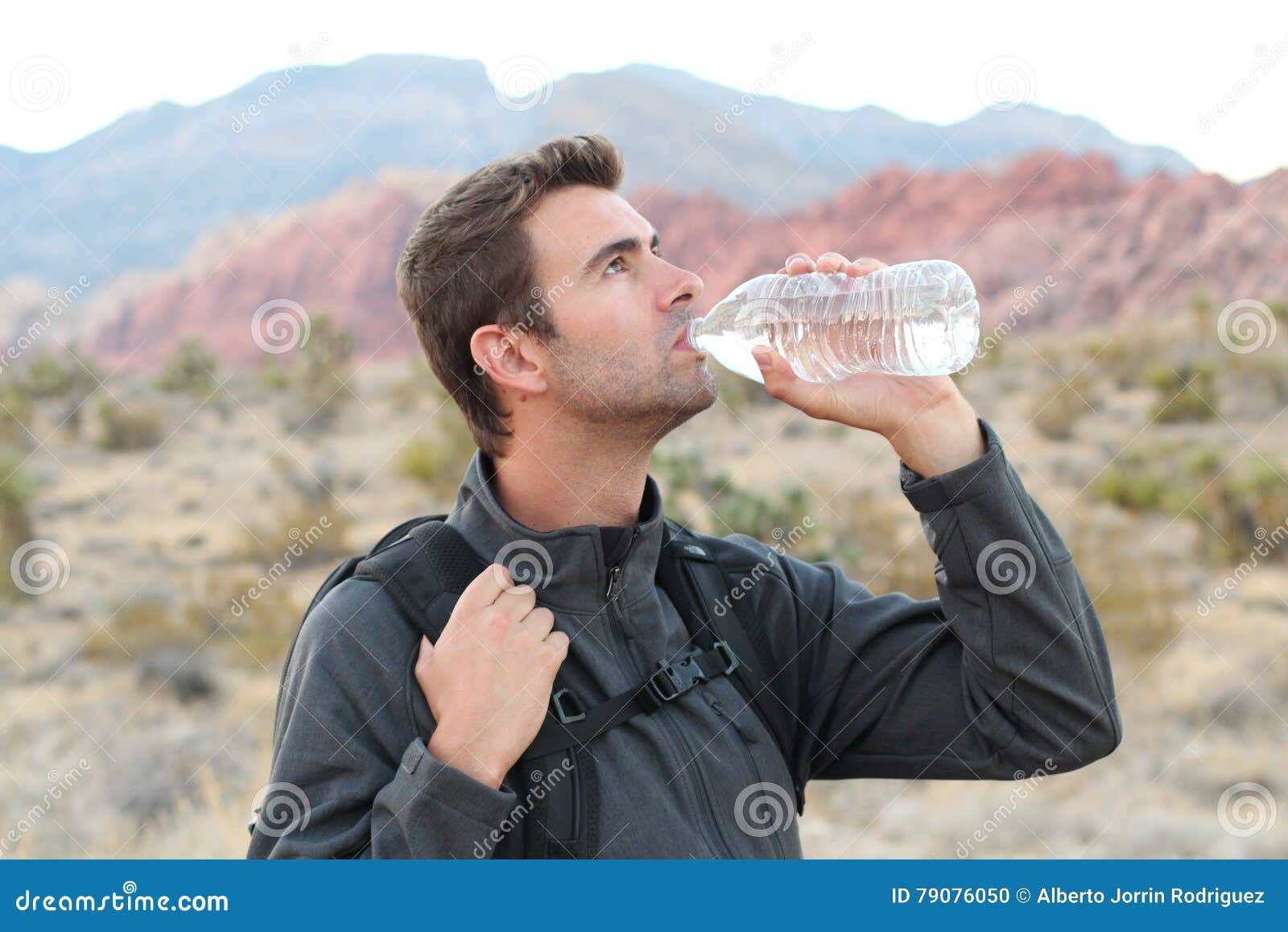 Side View of Young Man Drinking Water while Standing during a Hike ...